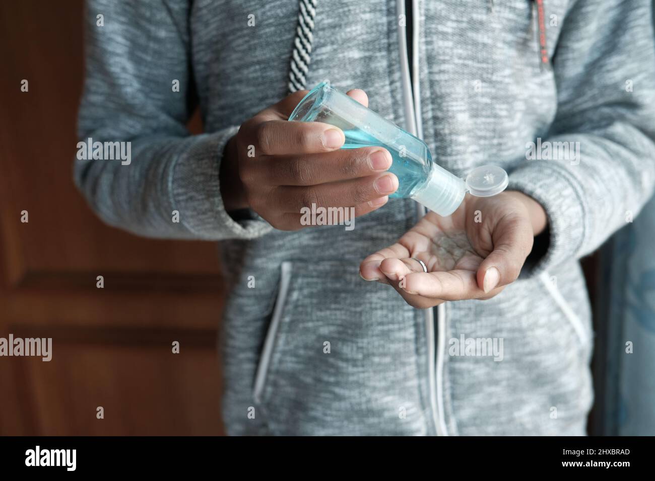 Using sanitizer liquid for preventing corona virus Stock Photo - Alamy