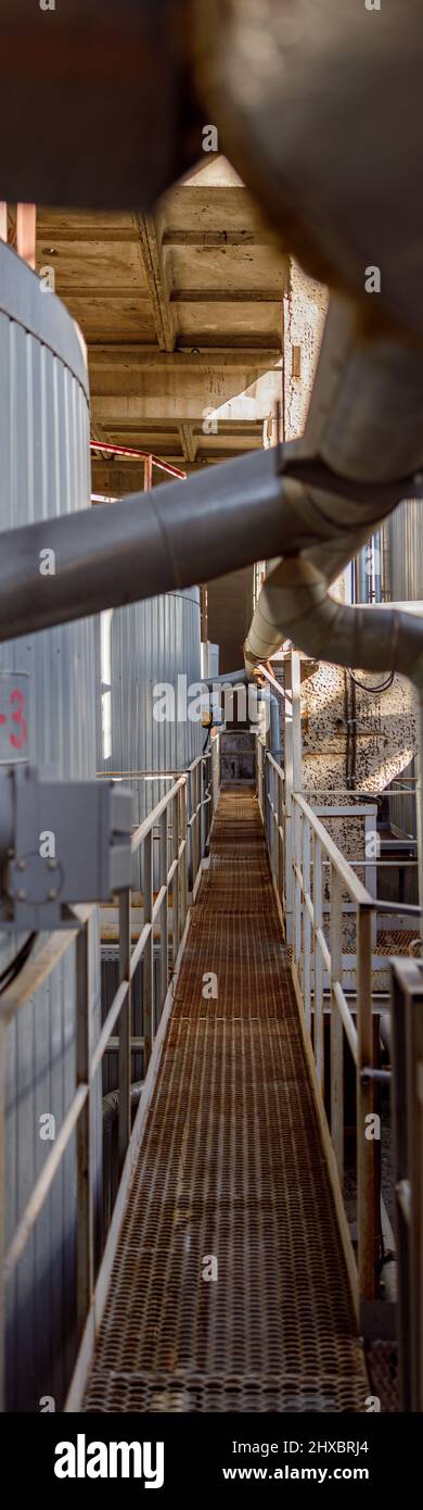 Industrial facility with metal bridge at factory Stock Photo - Alamy