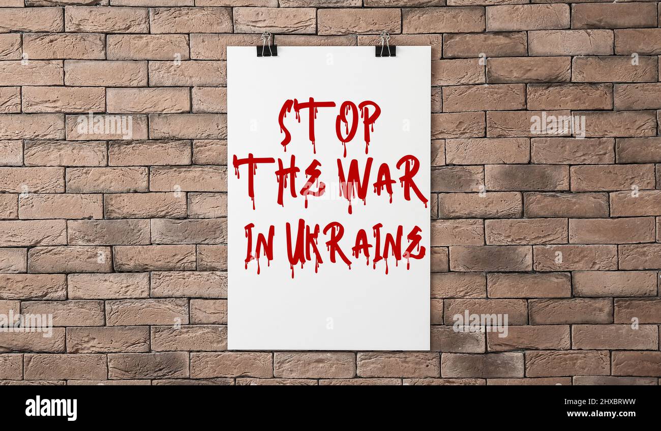 Poster with text STOP THE WAR IN UKRAINE written in blood on brick wall ...