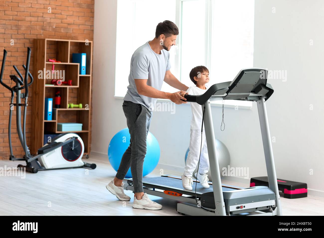 Little boy with his coach training on treadmill in gym Stock Photo - Alamy