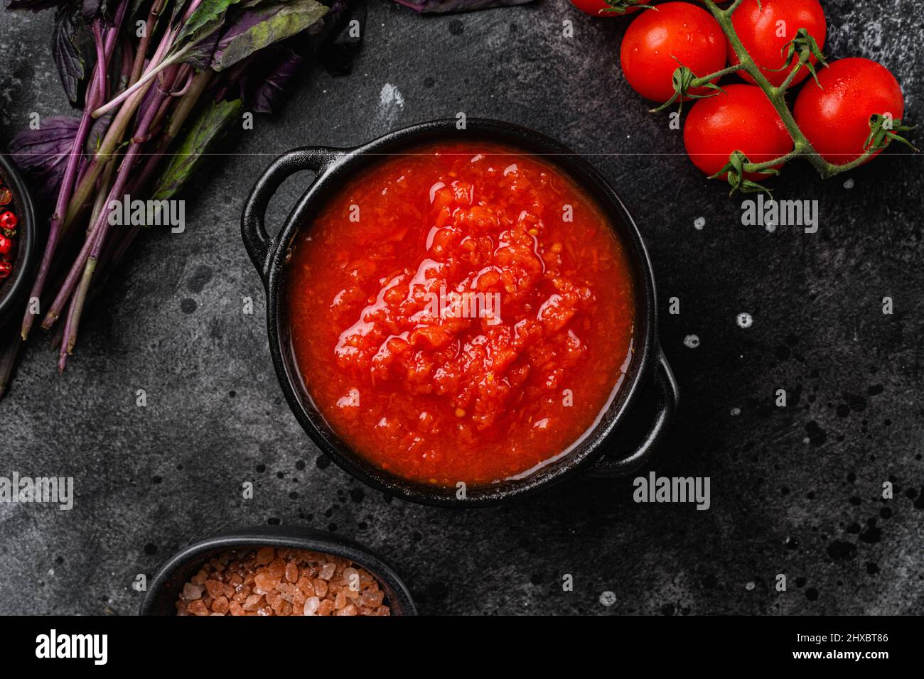Tomato sauce in small bowl, on black dark stone table background, top ...