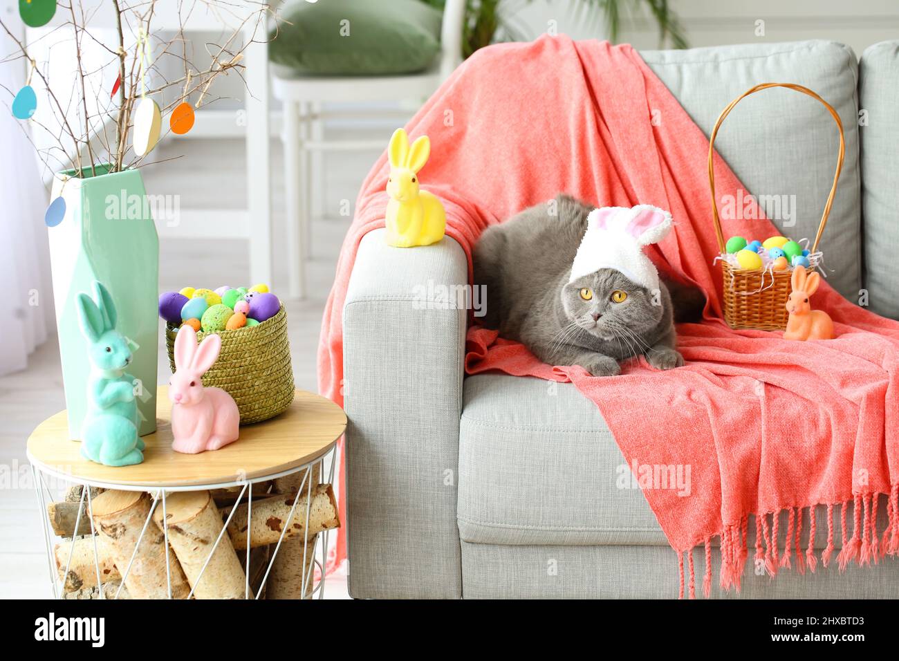 Cute Scottish Fold cat in bunny ears with Easter eggs and rabbits on ...