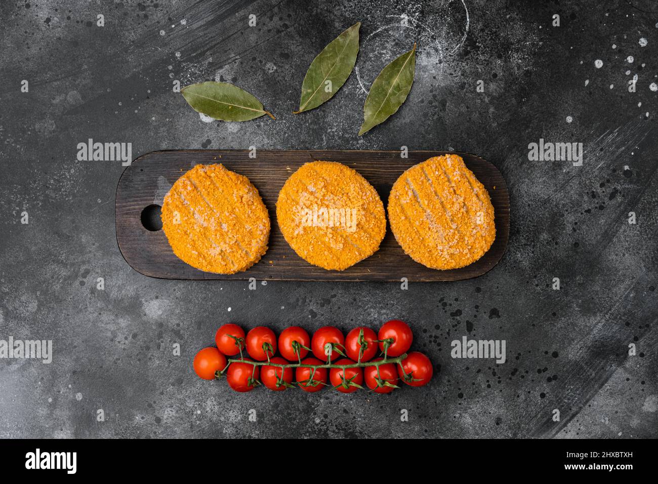 Breaded fish patties, on black dark stone table background, top view ...