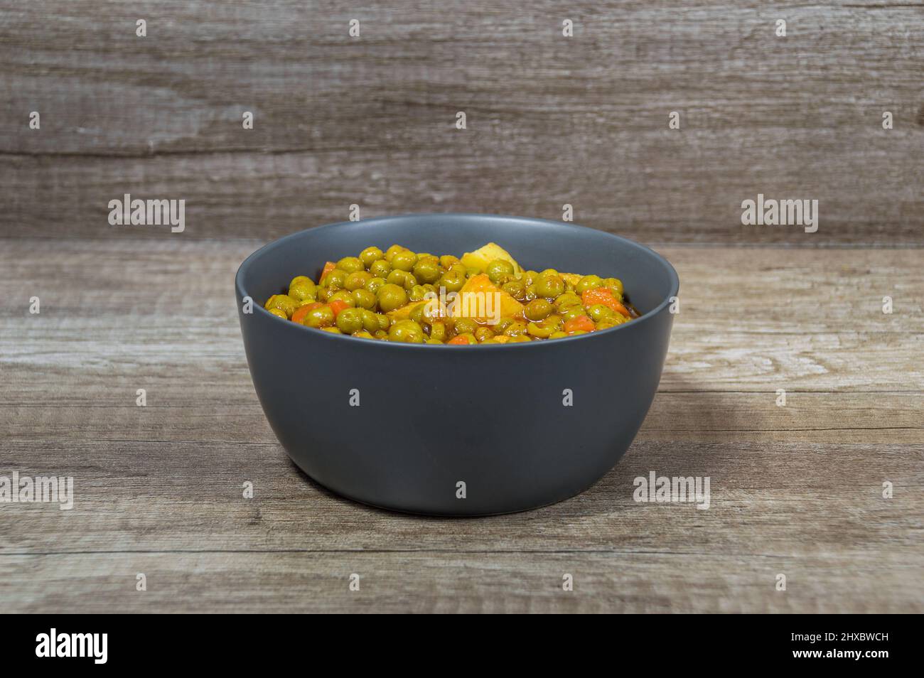 Fresh green peas with tomato sauce potatoes and carrot Greek food Stock ...