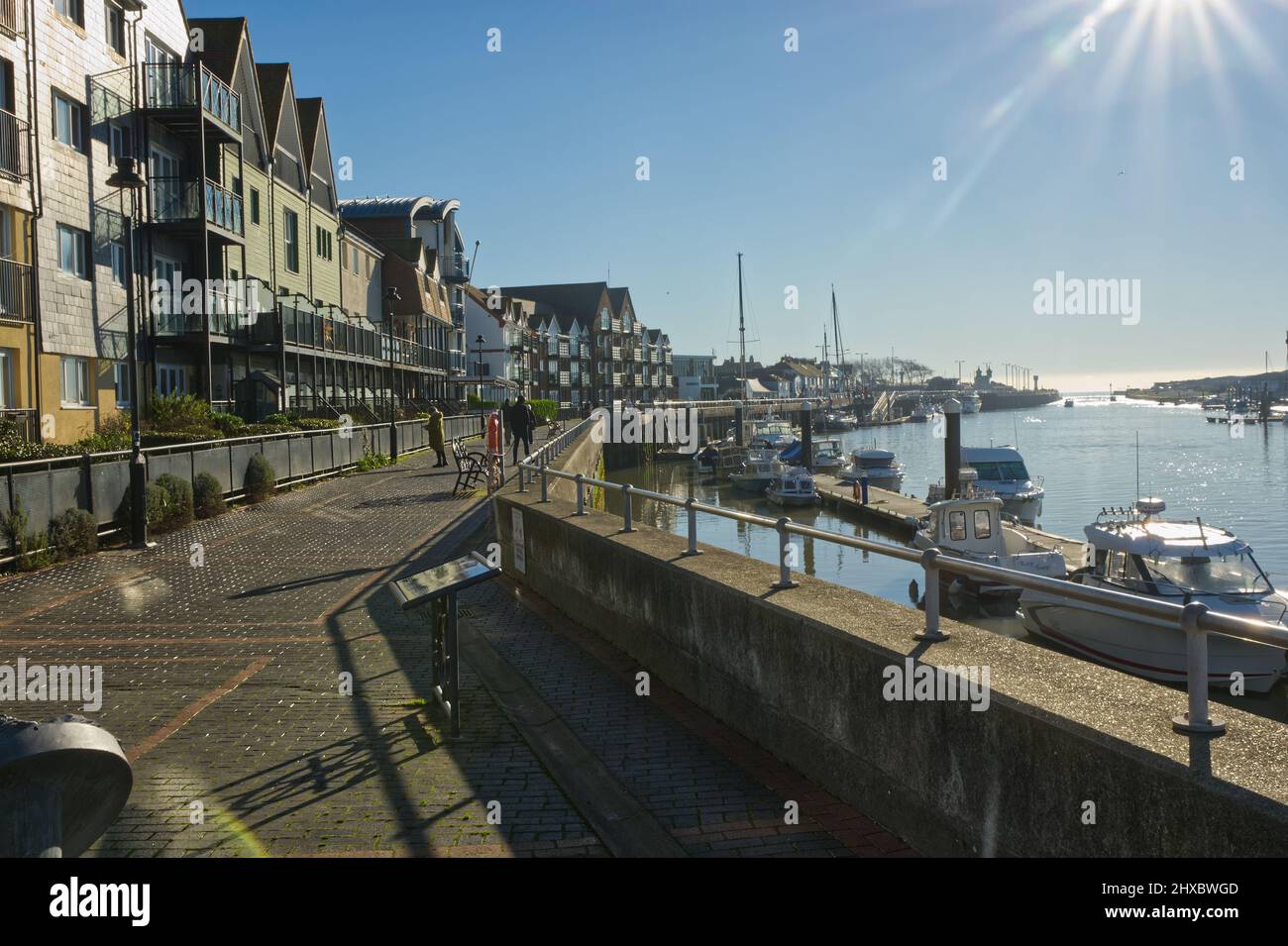 Riverside promenade and moored boats in harbour at Littlehampton, West ...