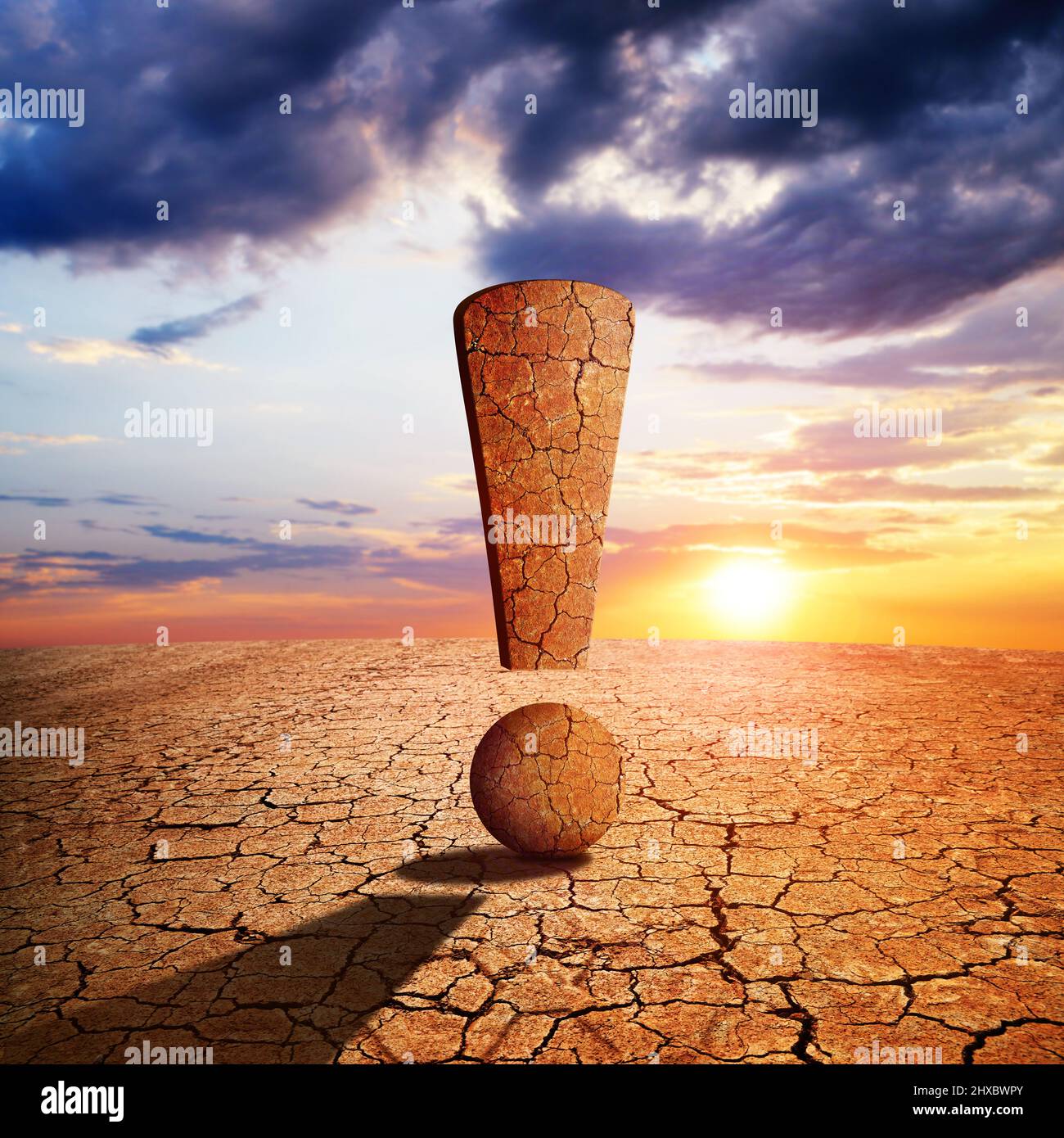 Exclamation mark in the dry landscape with cracked soil at sunset ...