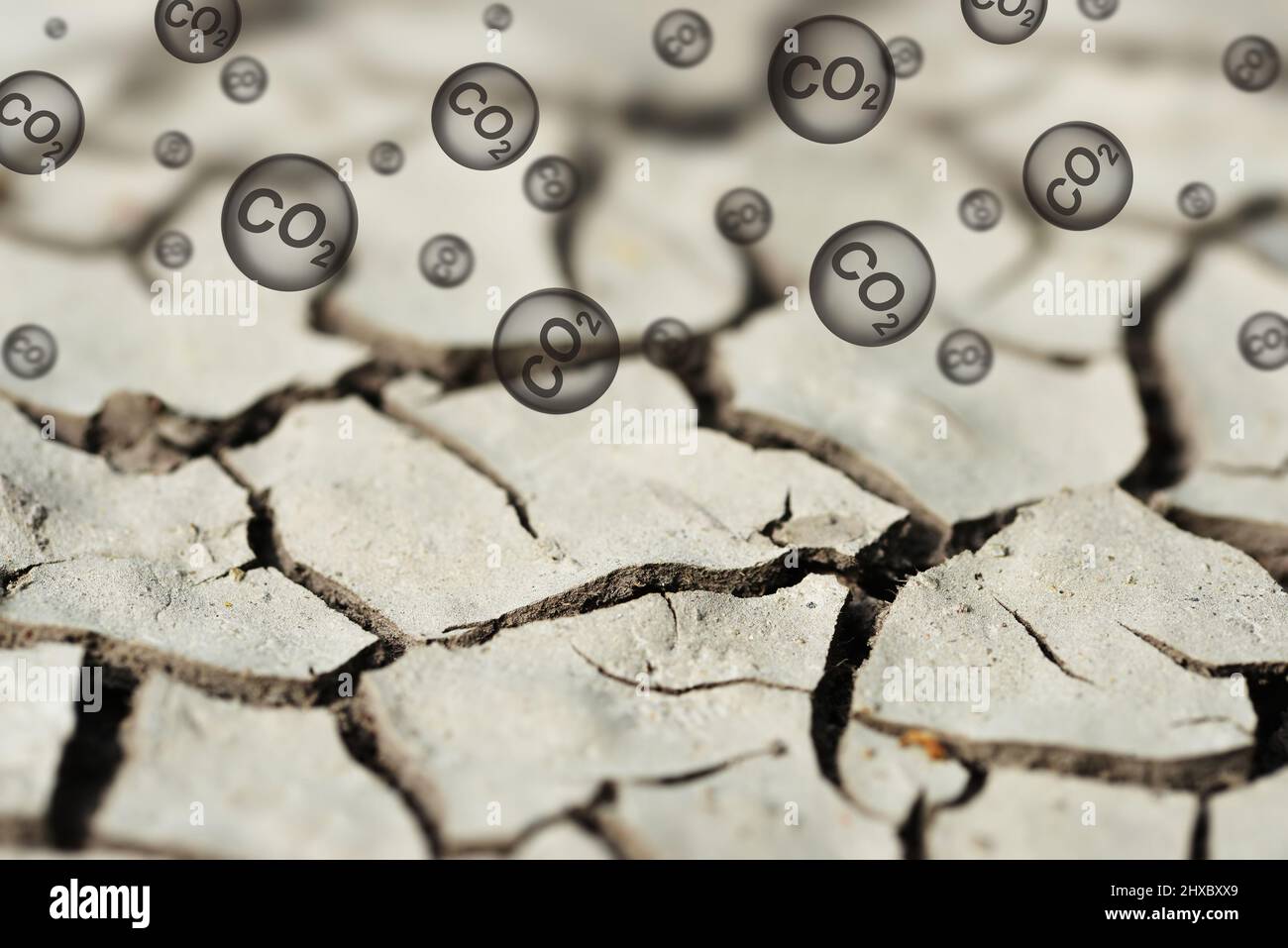 Carbon dioxide escaping from the arid cracked soil. Concept of climate ...