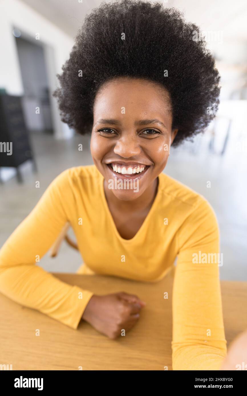 Portrait of happy african american mid adult female freelancer with ...