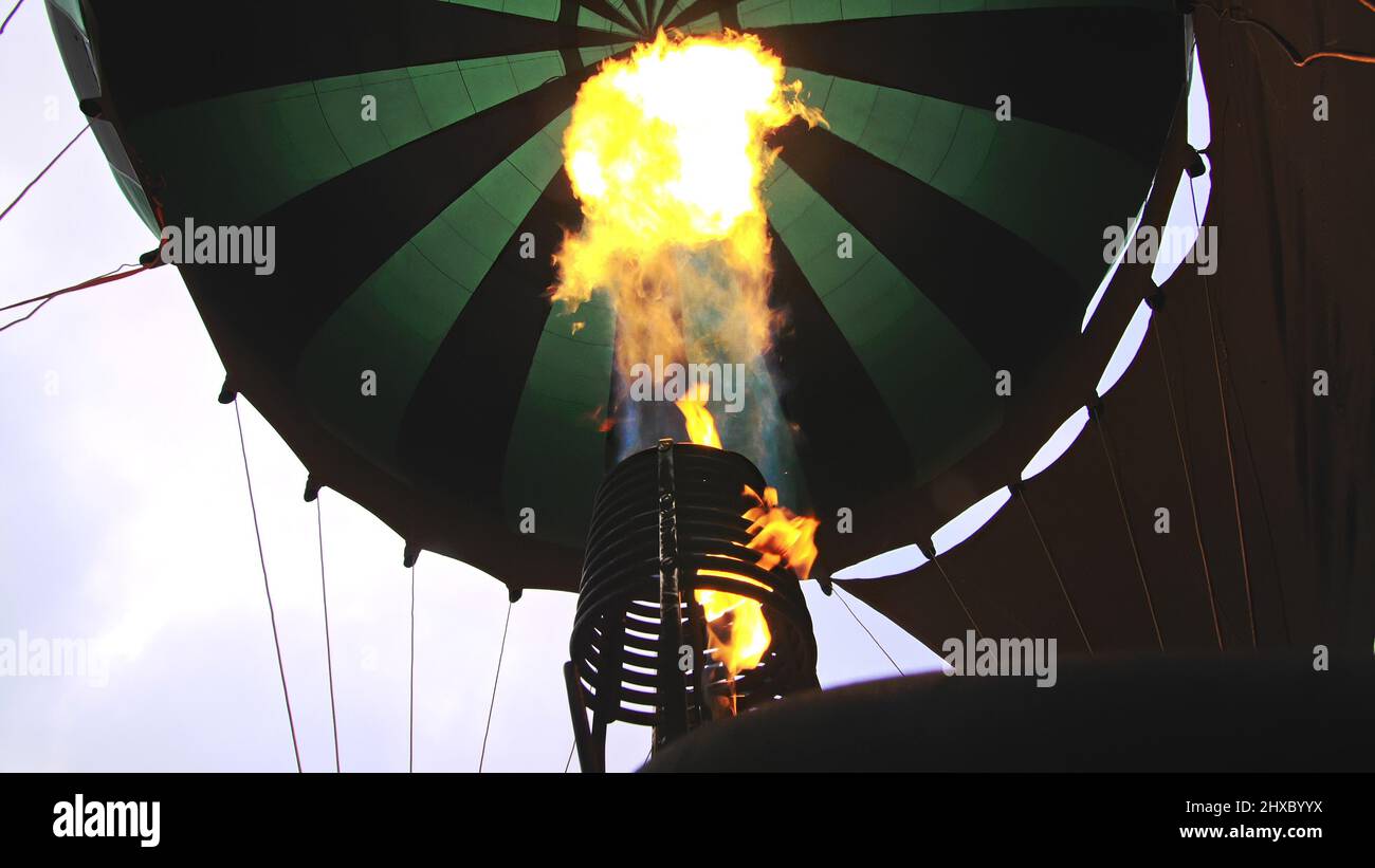 Adventure on hot air balloon watermelon. Burner directing flame into ...