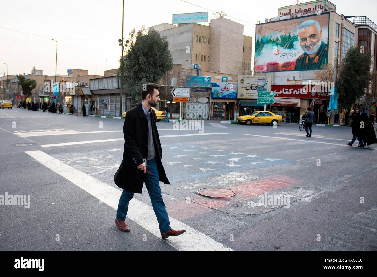 Qom, Iran. 10th Mar, 2022. The U.S flag is seen on the ground in front ...