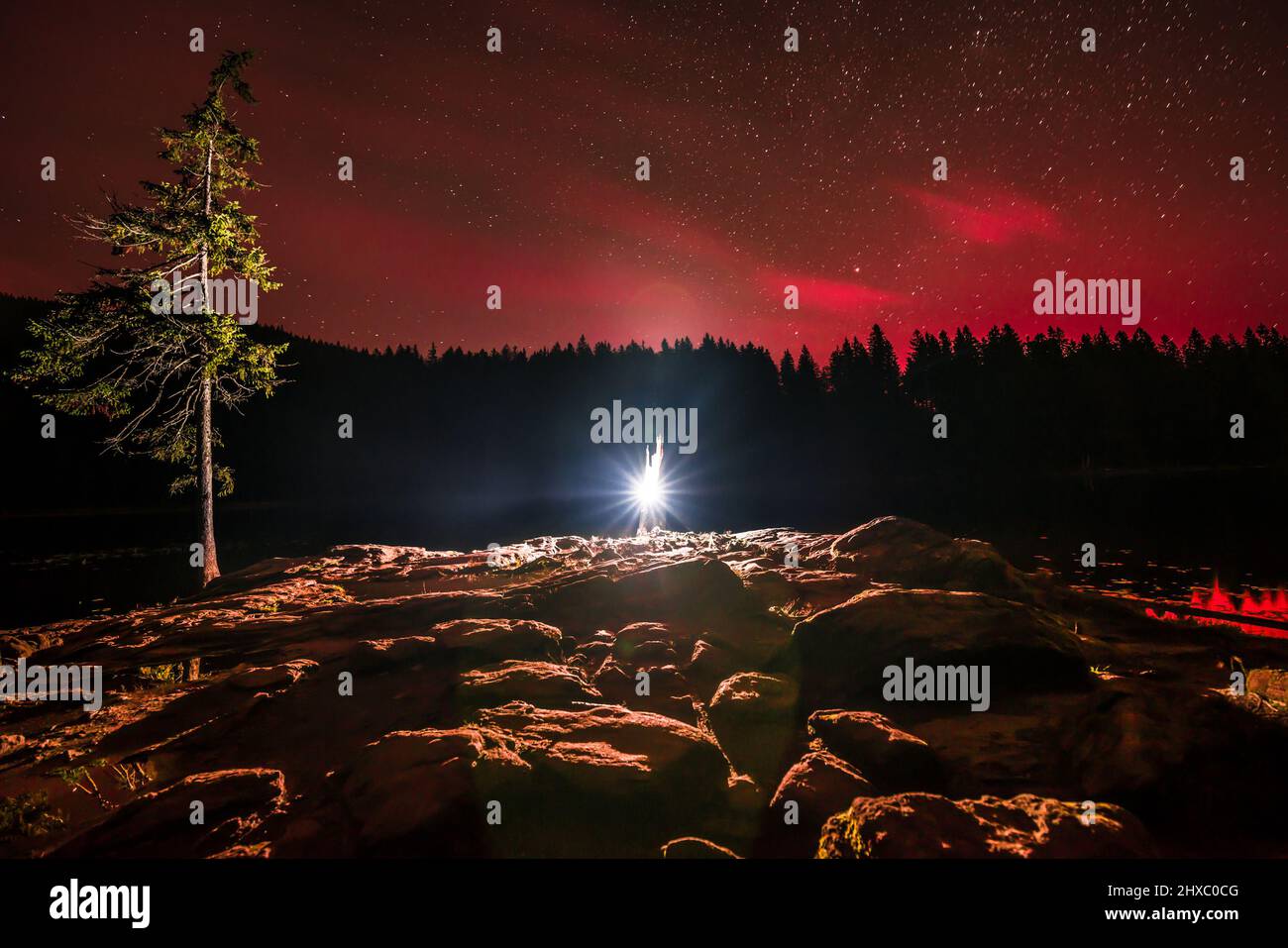 Red glowing sky at night with stars milky way and shooting star at big ...