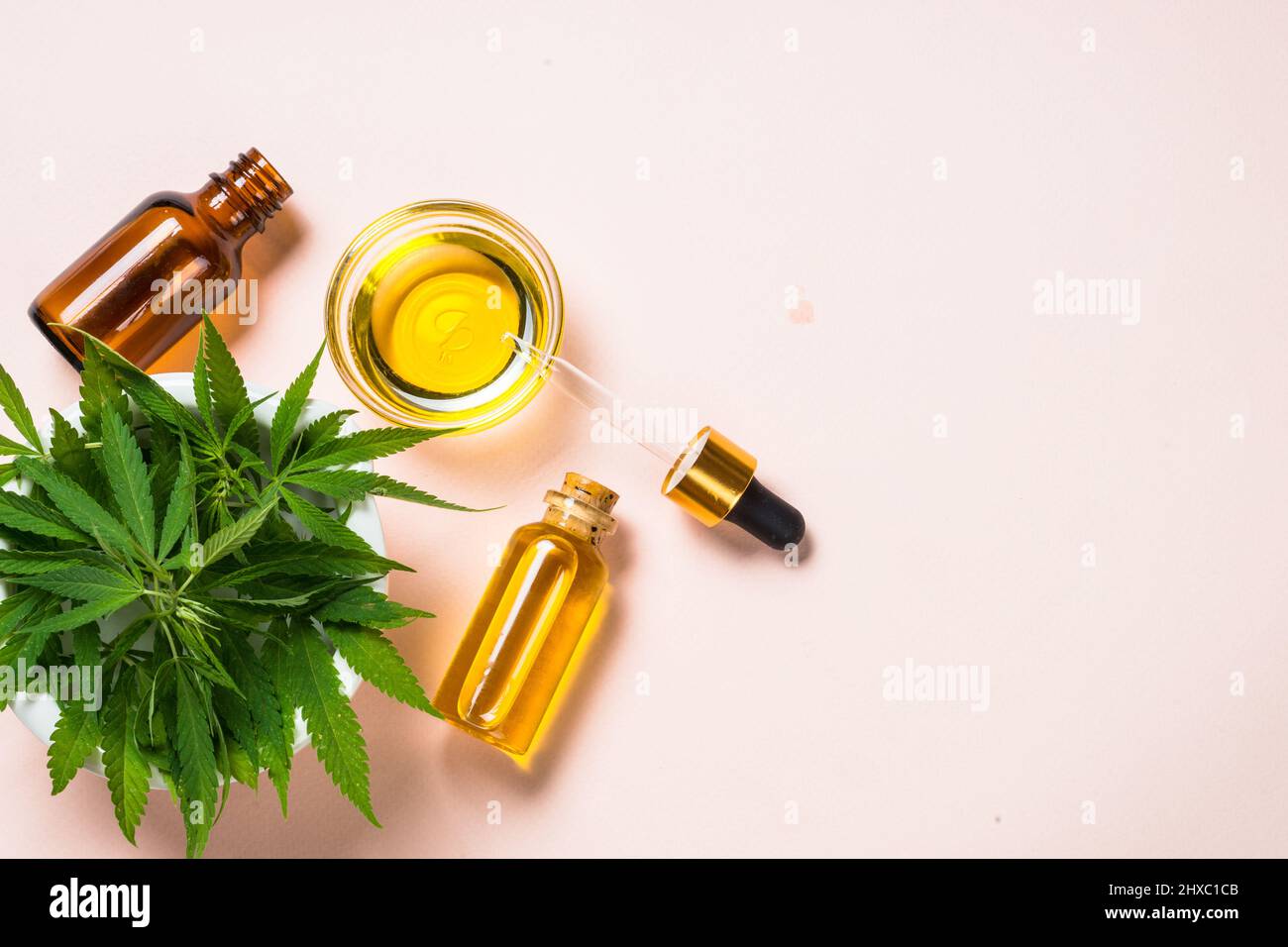 Cannabis oil in glass bottles and cannabis leaves at white table Stock ...