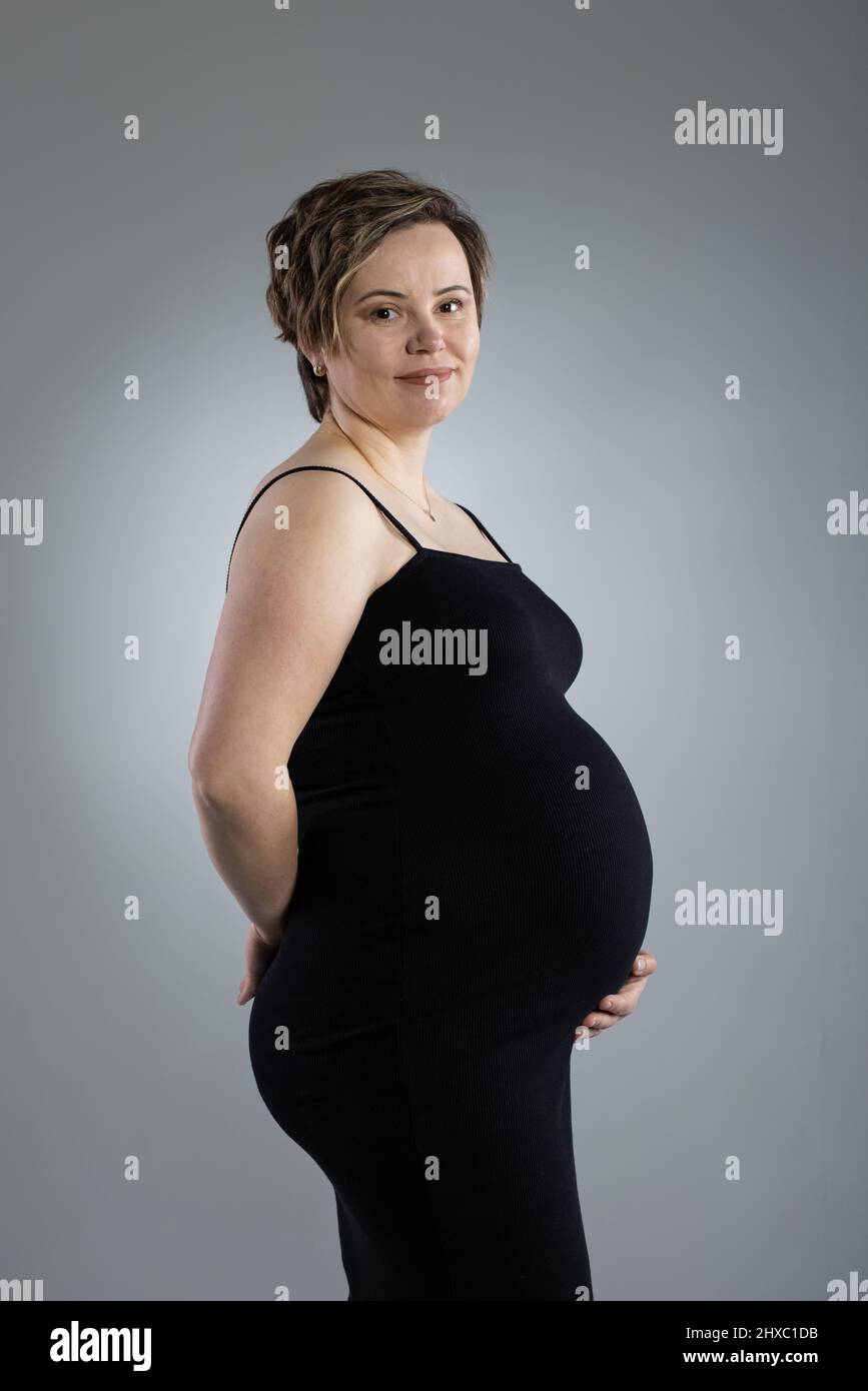 Portrait of pregnant woman on her third trimester, two weeks before ...