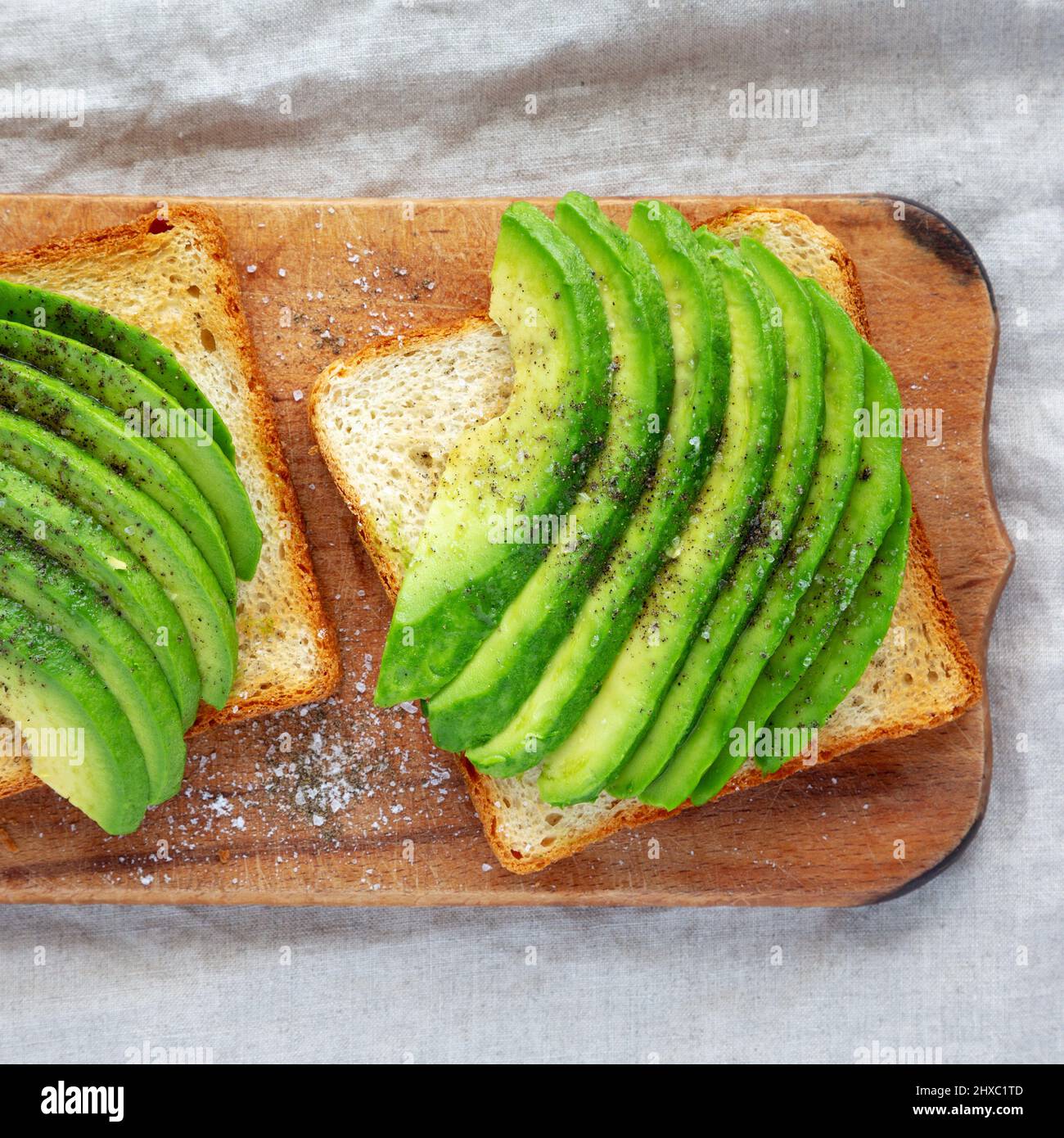 Homemade Avocado Toast on a rustic wooden board, top view. Flat lay ...