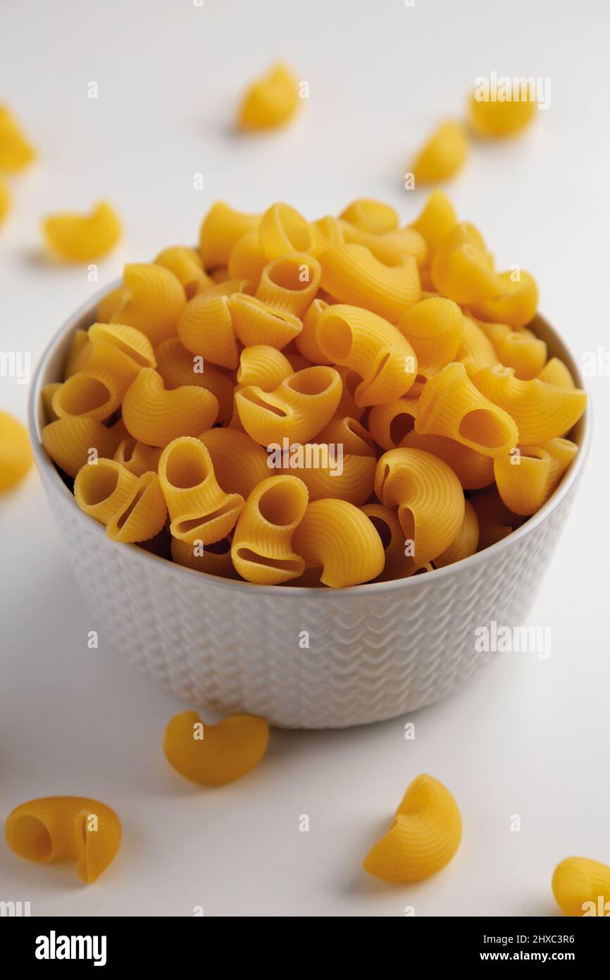 Raw Dry Organic Pipe Rigate Pasta in a Bowl on white background, side ...