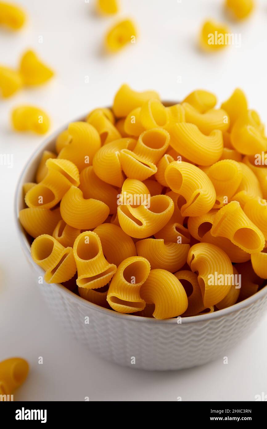 Raw Dry Organic Pipe Rigate Pasta in a Bowl on white background, side ...