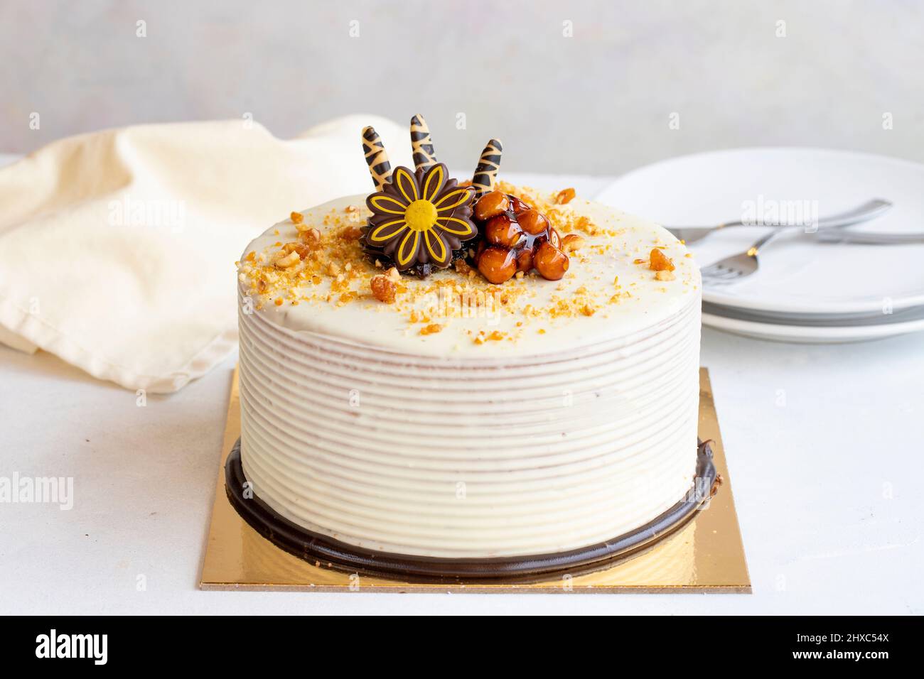 Celebratory cake with white chocolate croquant on a white background ...