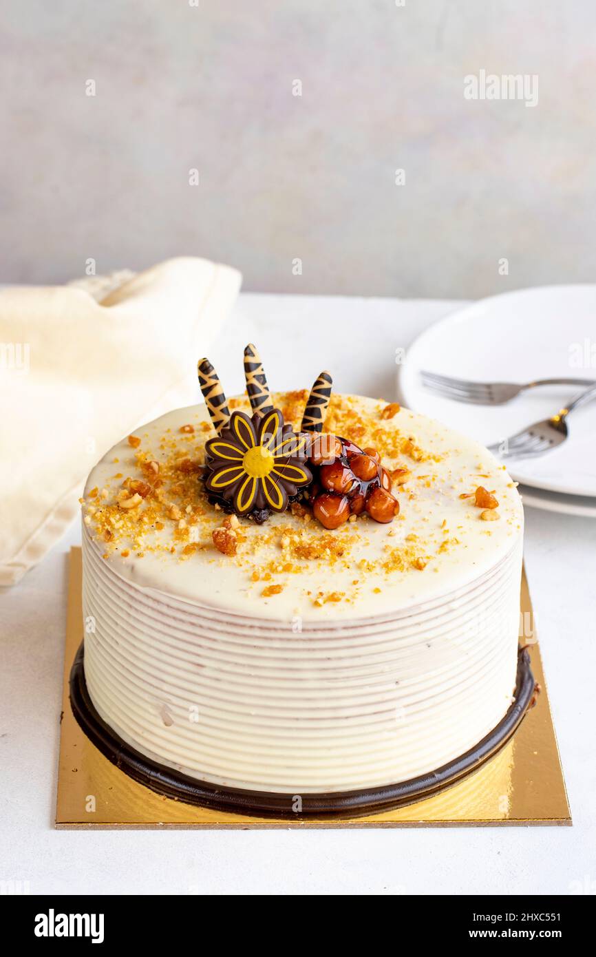 Celebratory cake with white chocolate croquant on a white background ...