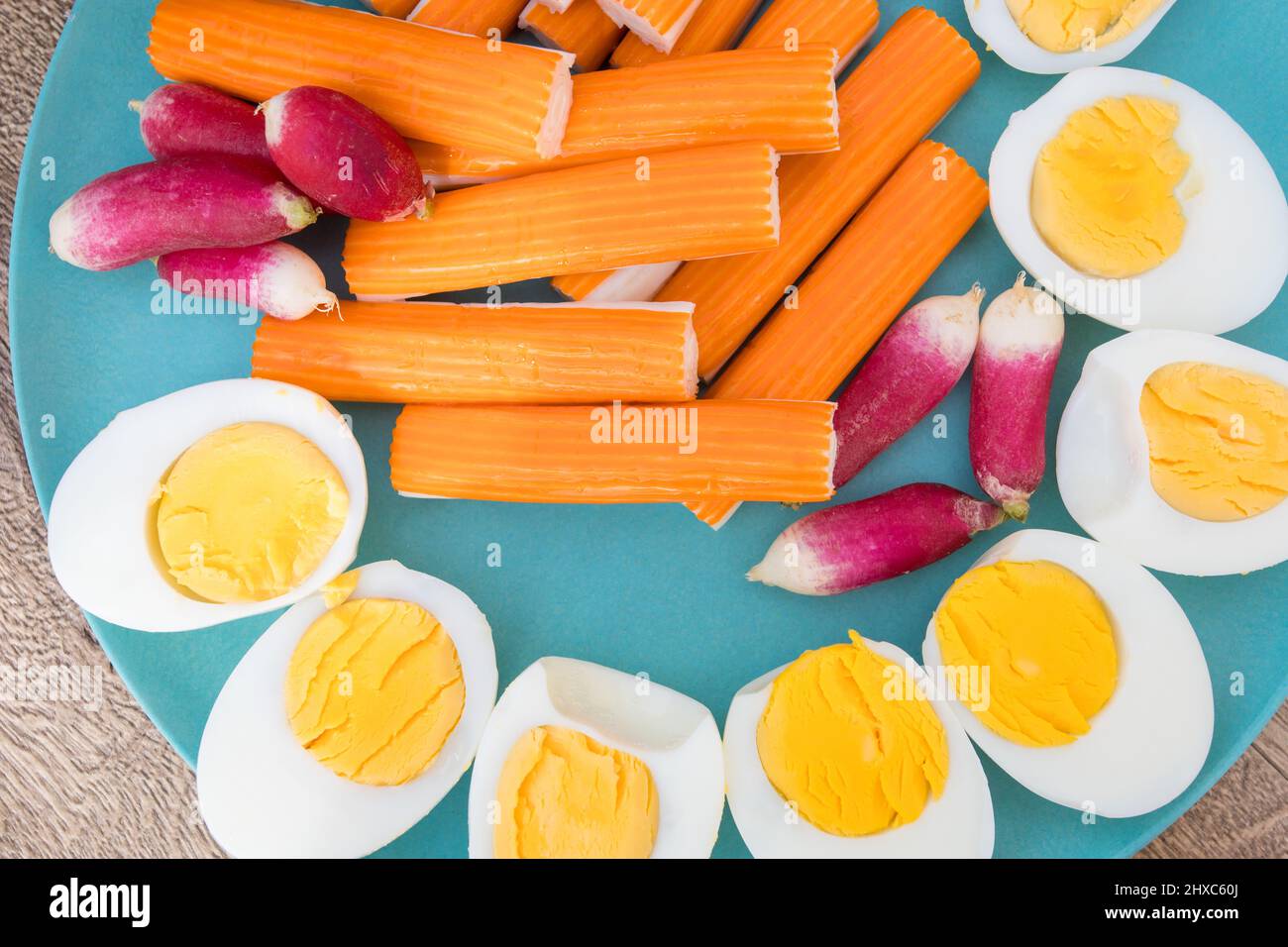 plate of surimi, hard-boiled eggs, and radishes Stock Photo - Alamy