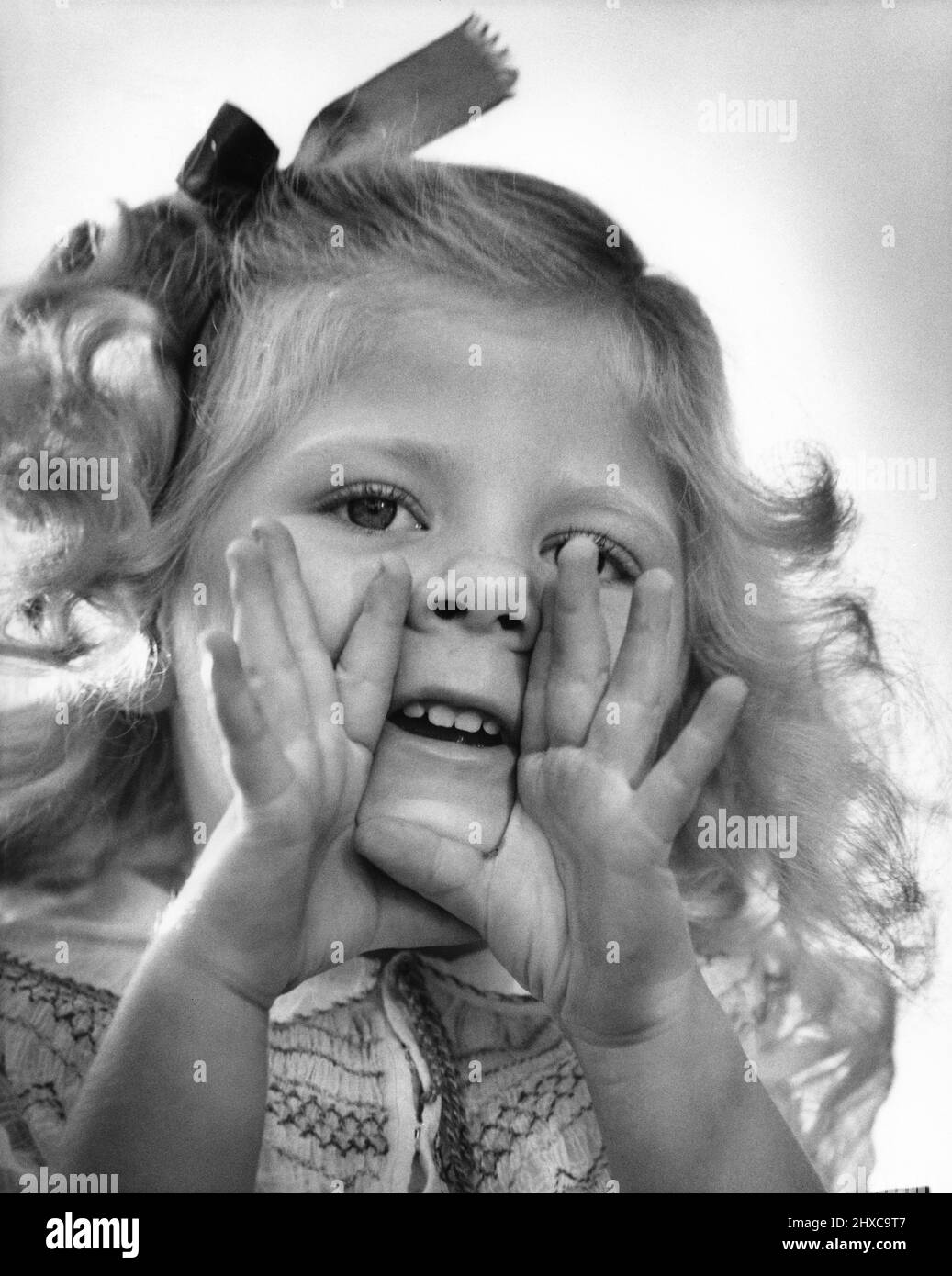 Little girl with her hands cupped to her mouth calling out Stock Photo ...