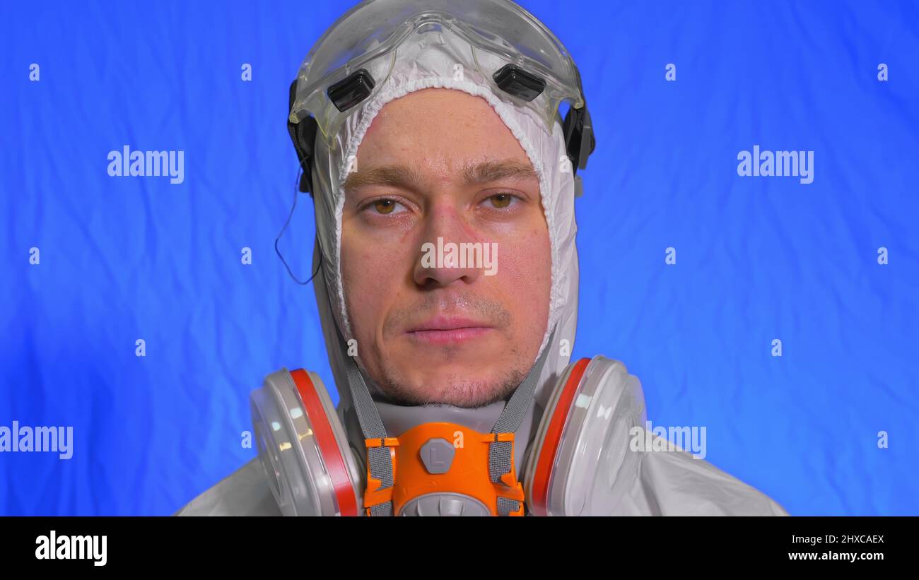 Scientist virologist in respirator. Slow motion. Man close up look ...