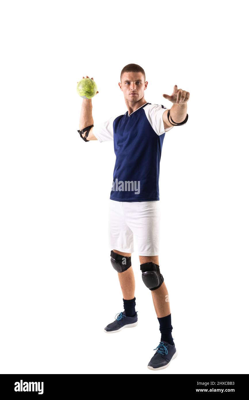 Confident male caucasian handball athlete playing while throwing ball ...