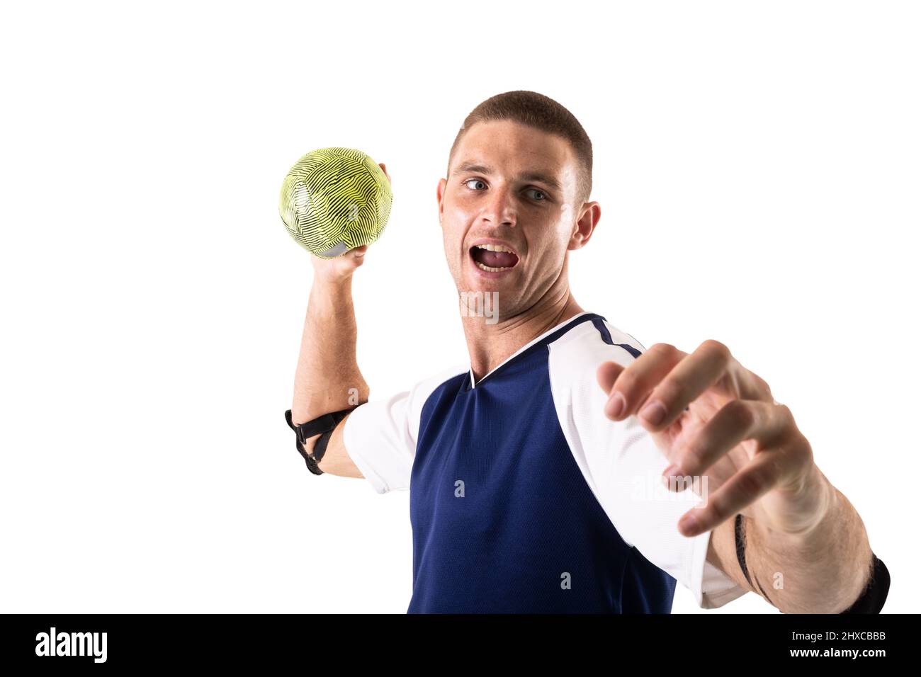 Young male caucasian player holding ball while playing handball against ...