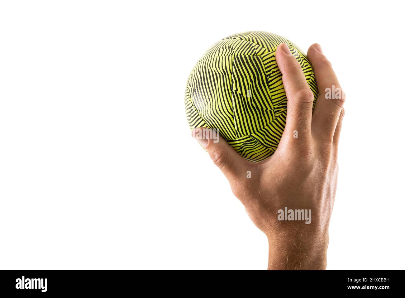 Cropped hand of caucasian athlete holding green ball playing handball ...