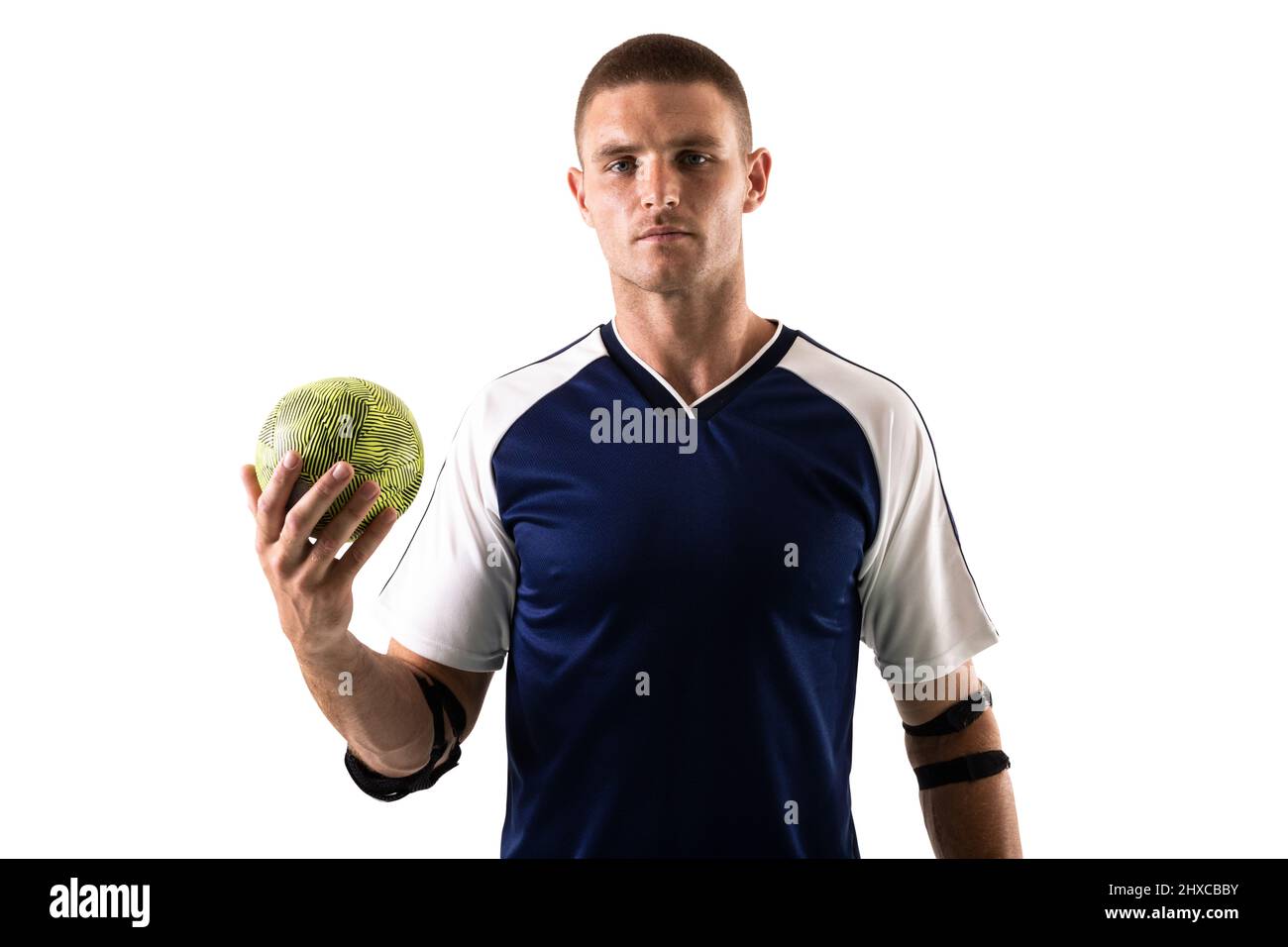 Portrait of confident young male caucasian handball player holding ball ...
