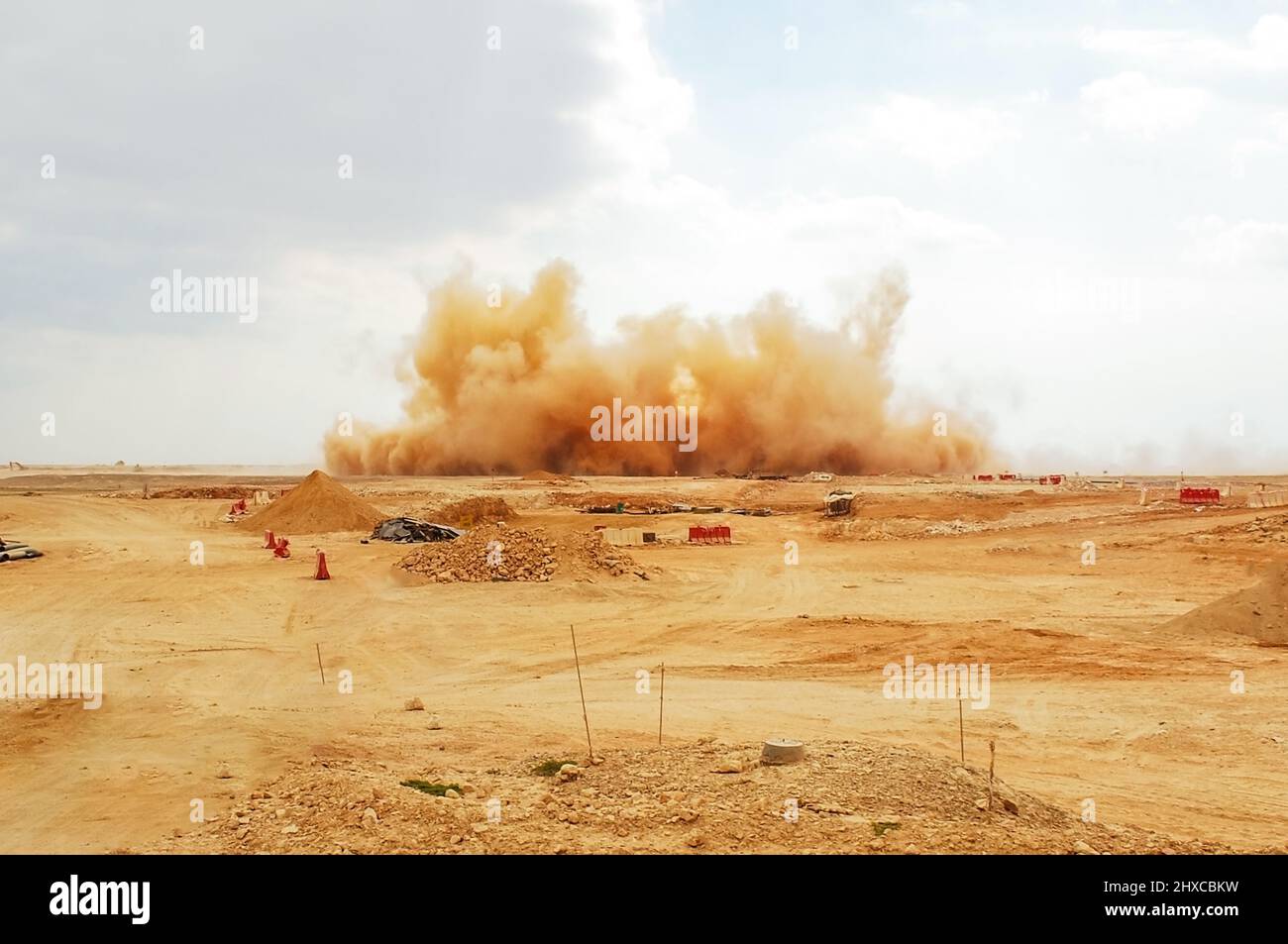 Dust clouds and flying rock during detonator blast in the desert Stock ...