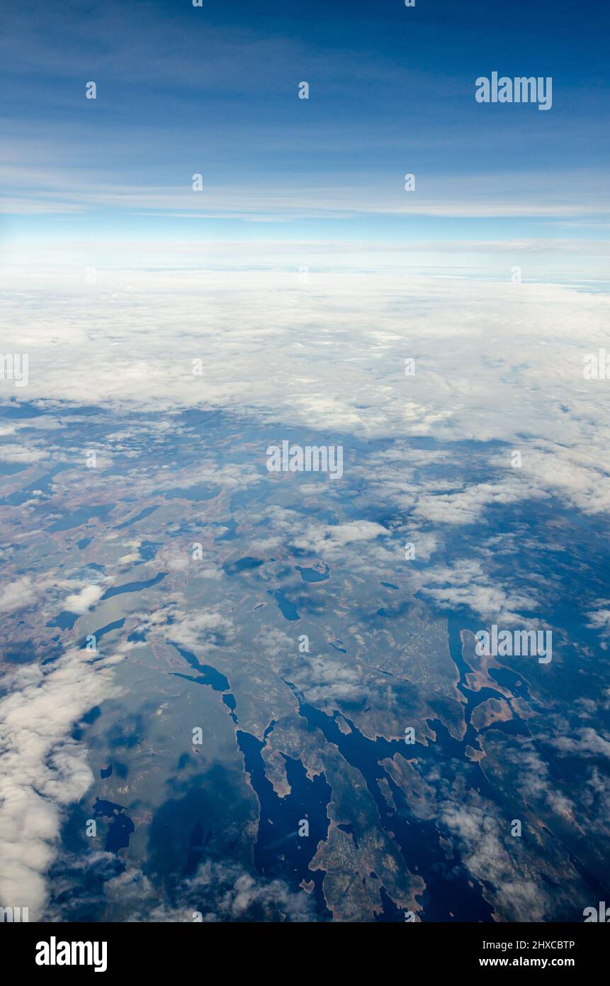 Plane wing, white clouds, blue sky and ground Stock Photo - Alamy