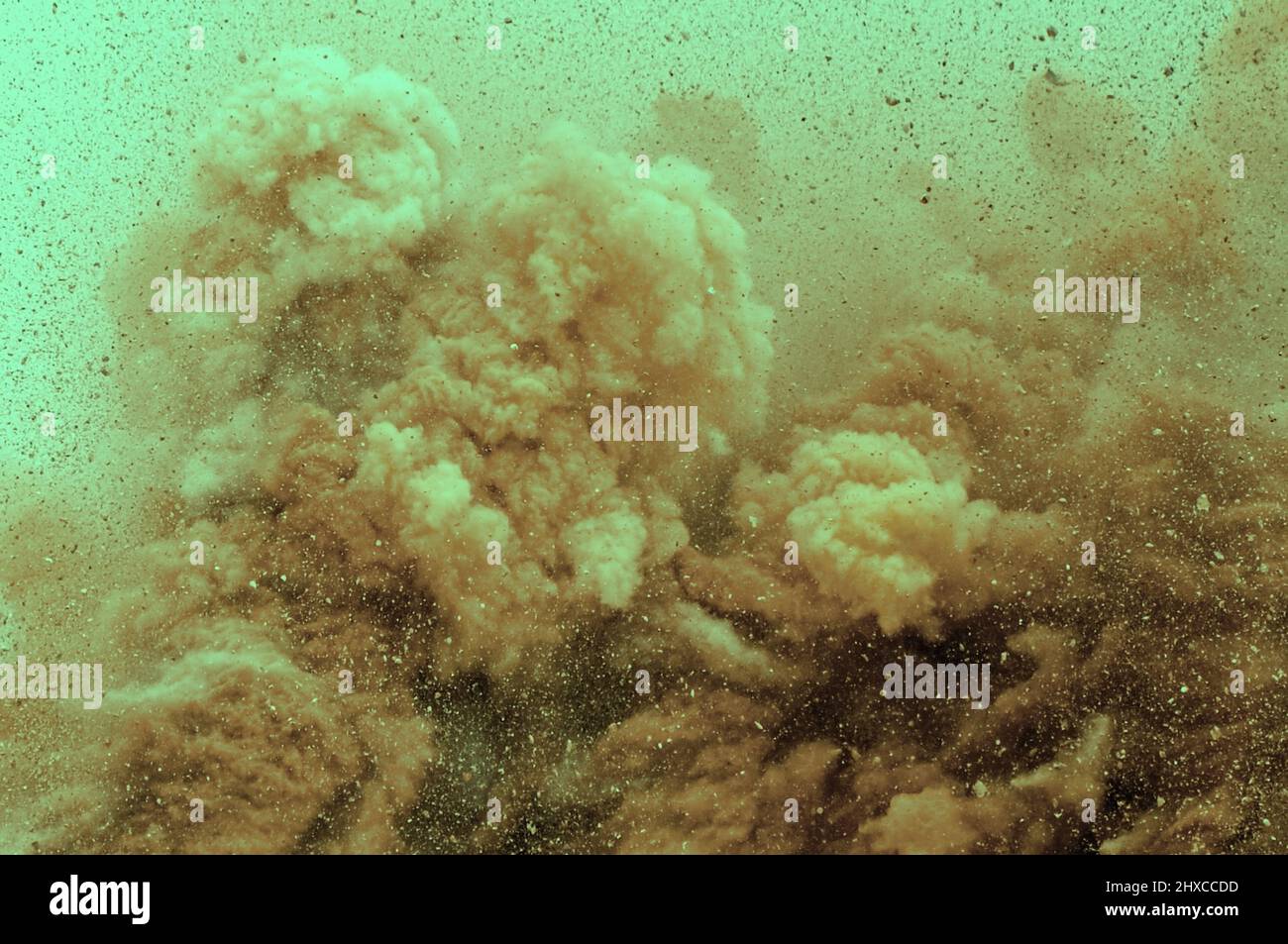 Close-up of dust storm during detonator blasting on the mining site ...