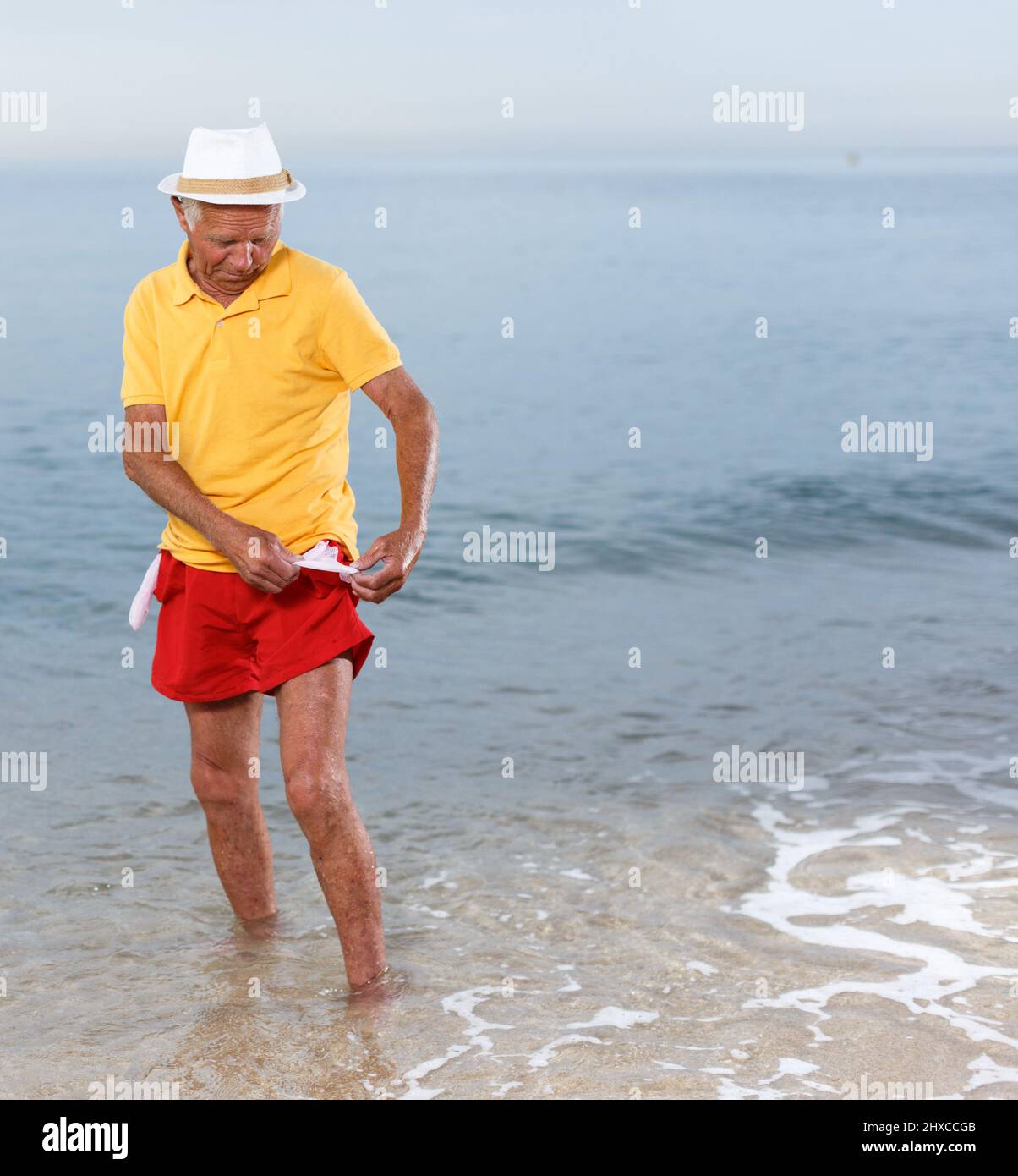 Serious man shows empty pockets near ocean Stock Photo - Alamy