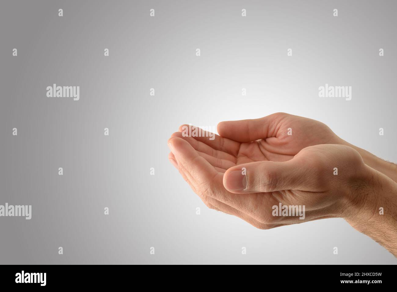 Hands with palms up of a religious man with offer gesture with isolated ...