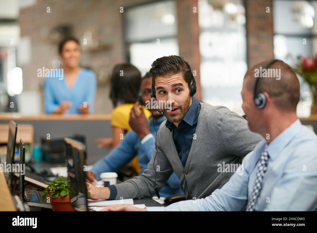 Giving him some advice on a call. Cropped shot of a group of creative ...