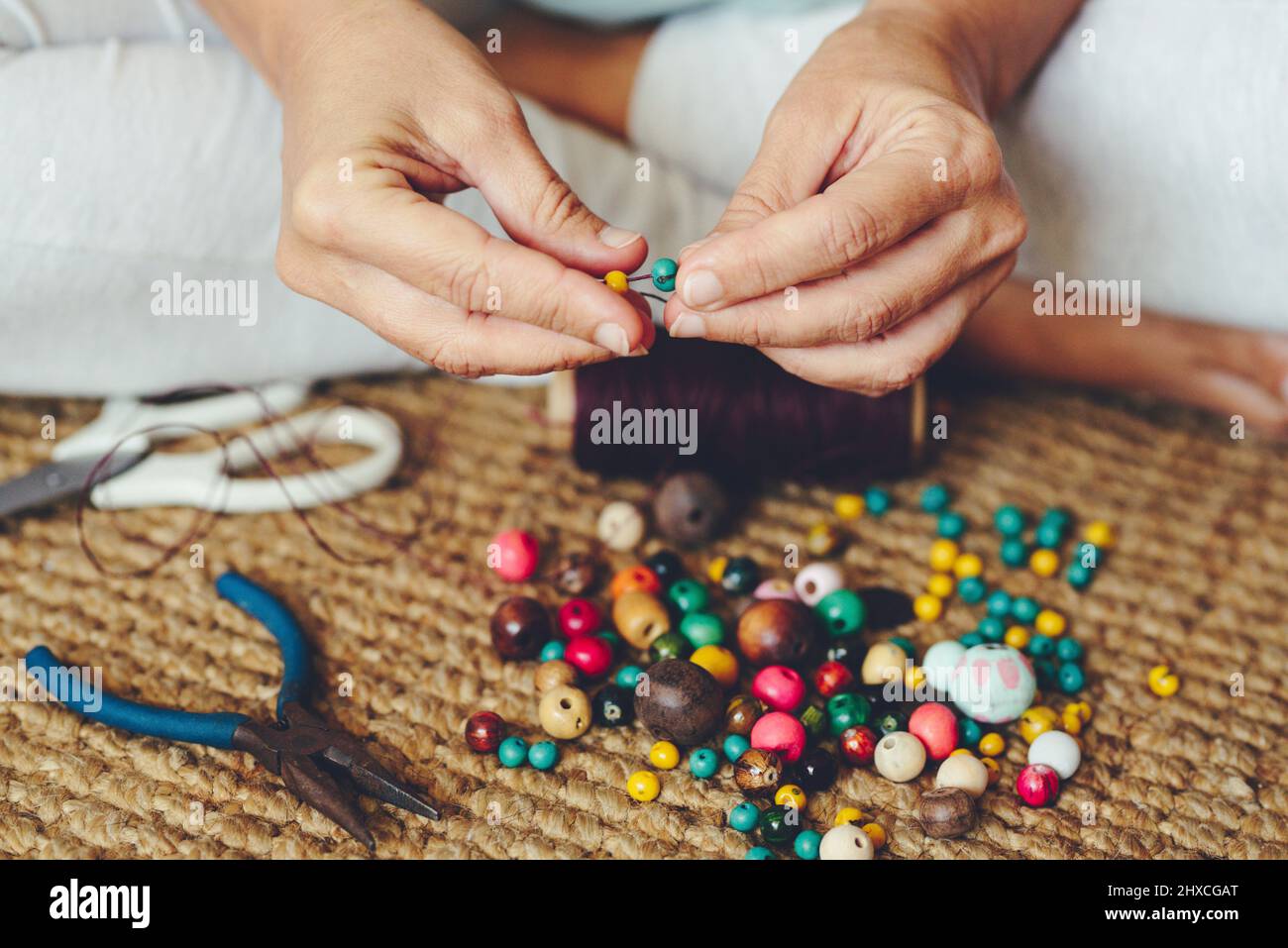 Hand craft woman doing beads hi-res stock photography and images - Alamy