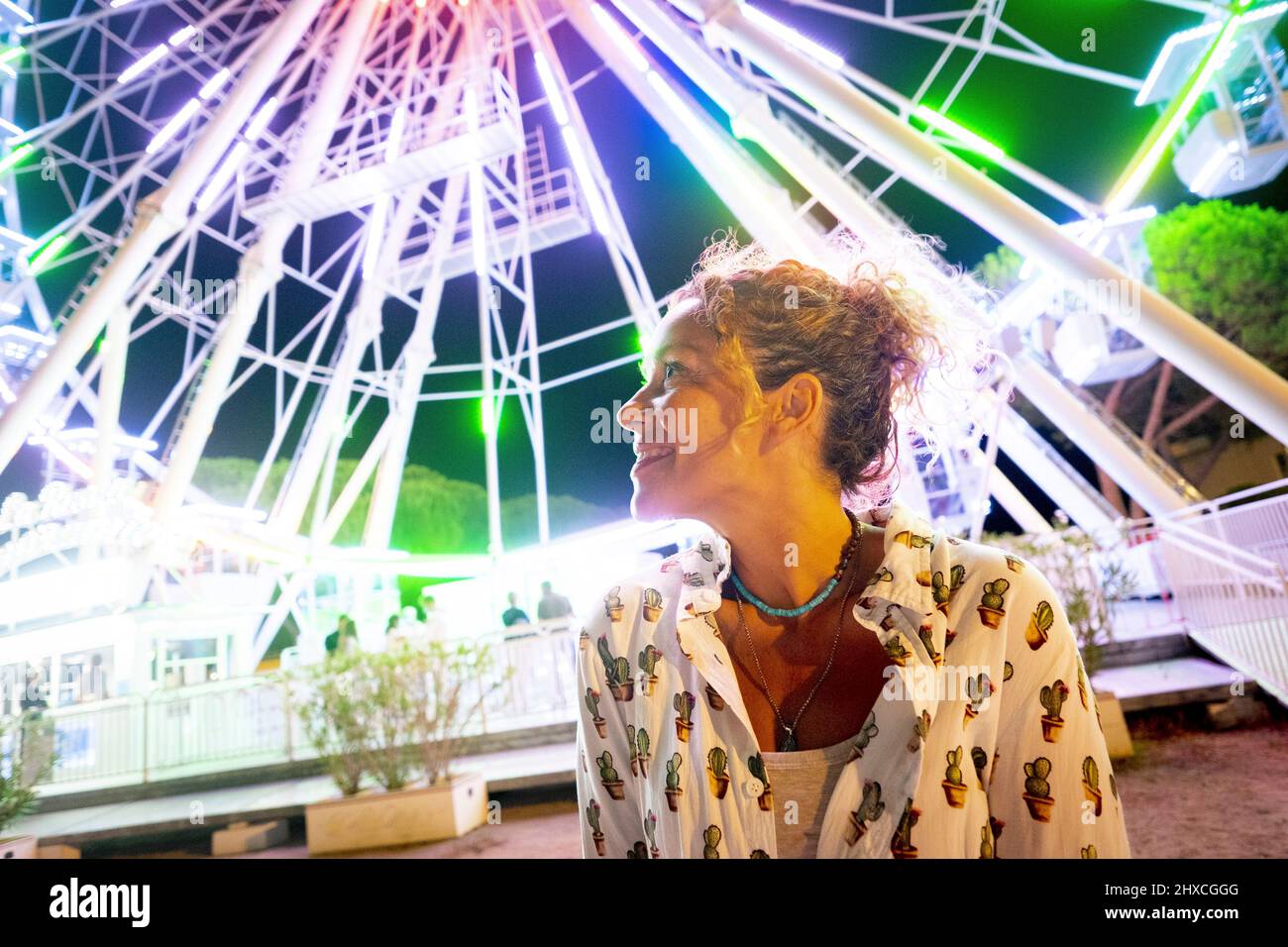Woman looking at ferris wheel hi-res stock photography and images - Alamy