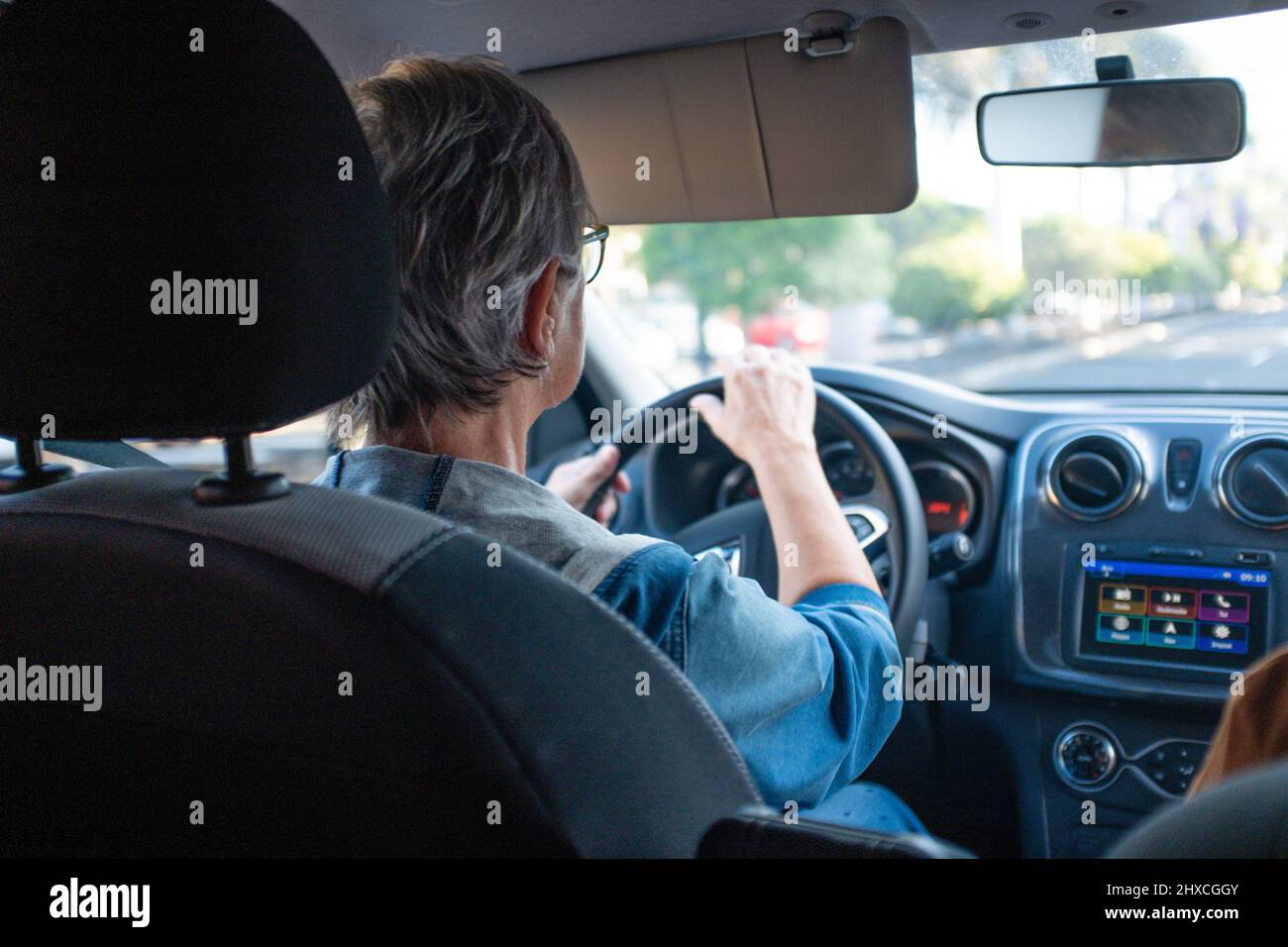 Senior woman, driving car, from behind, detail Stock Photo - Alamy