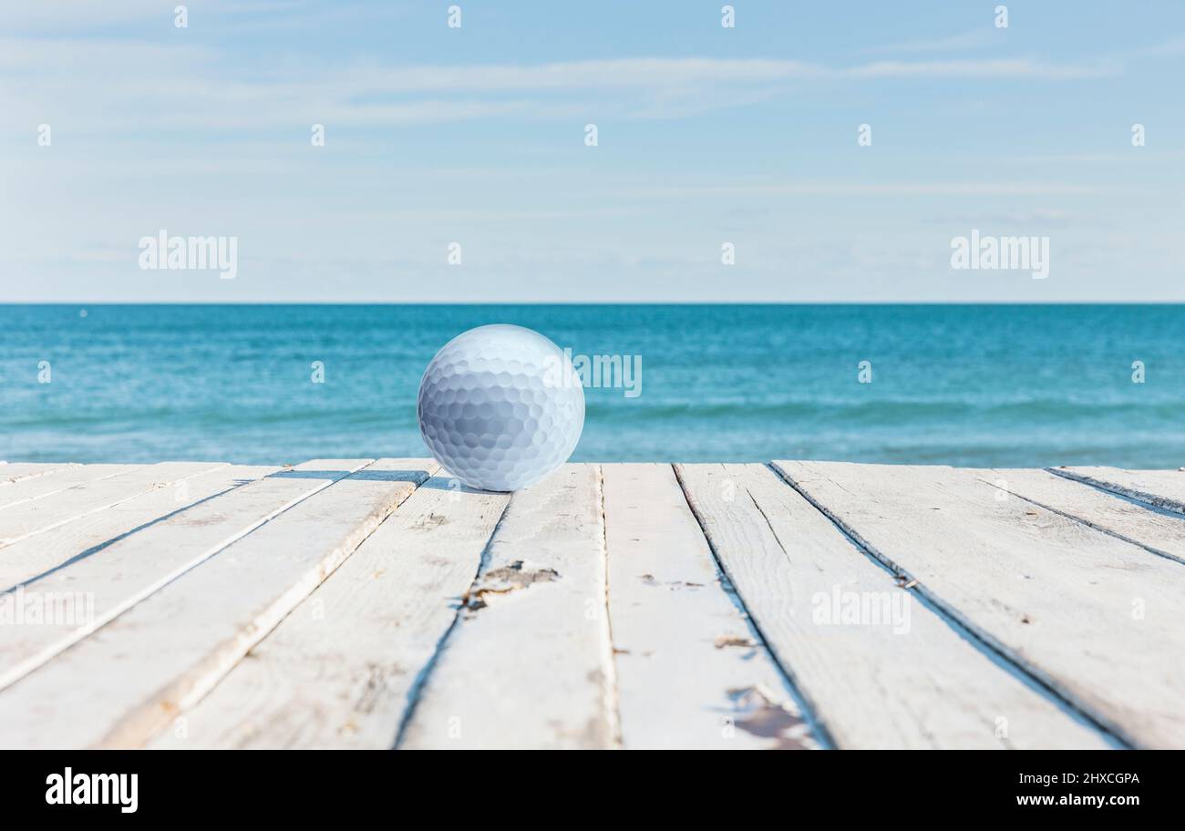 Golf ball on a terrace of wood by the sea Stock Photo - Alamy