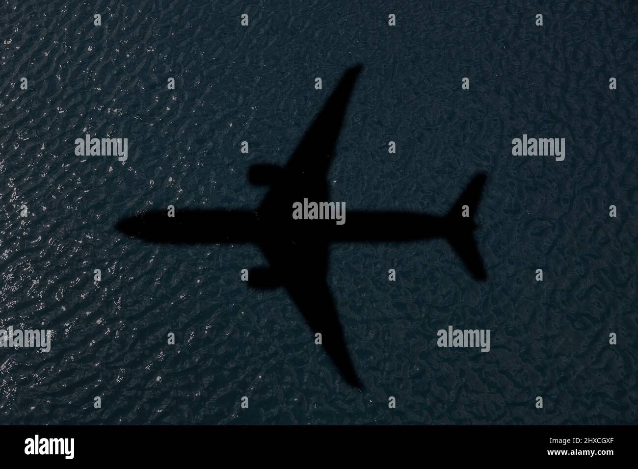 Water reflection of dark water, shadow of airplane Stock Photo - Alamy