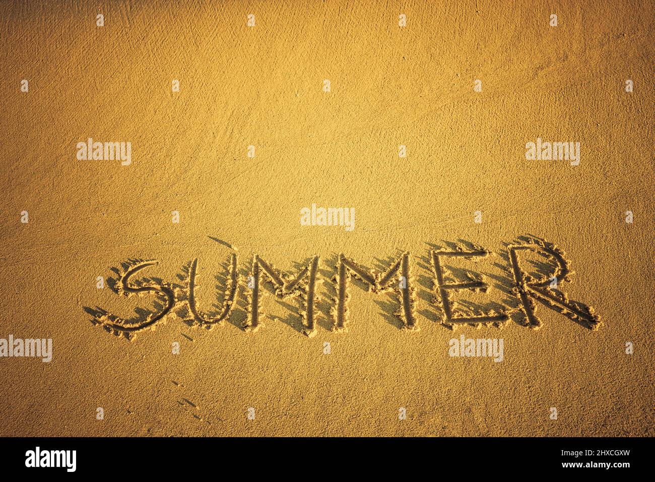 The word summer written in the sand Stock Photo - Alamy