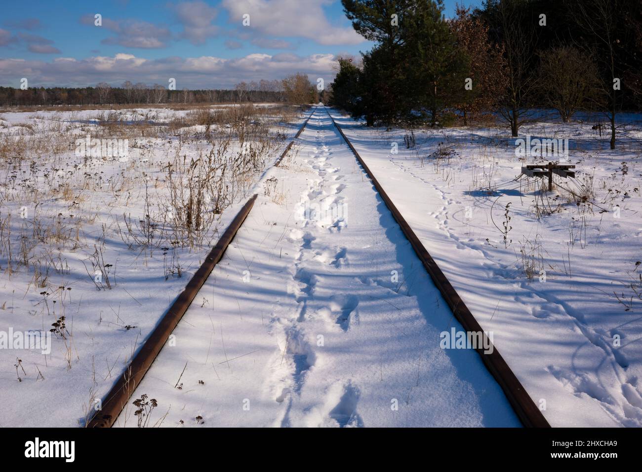 Snowy old unused railway tracks in winter, footprints in the snow Stock ...