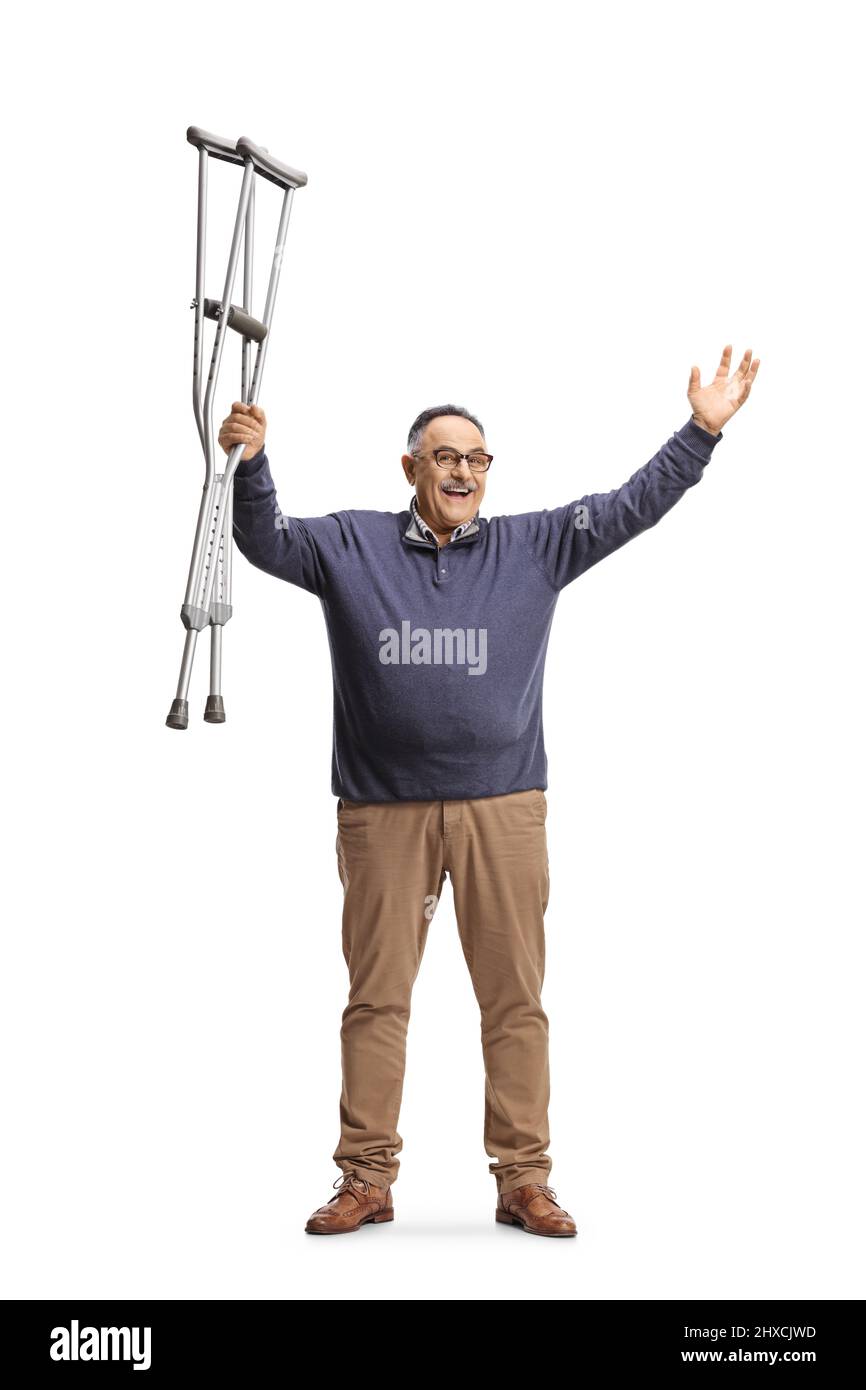 Happy mature man raising crutches and gesturing happiness isolated on ...