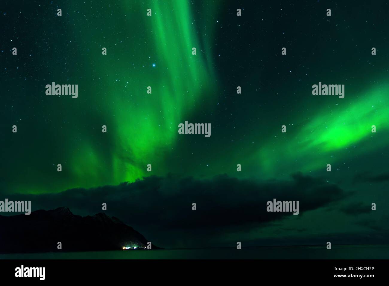 Northern Lights or Aurora Borealis dance over the fjord landscape Stock ...