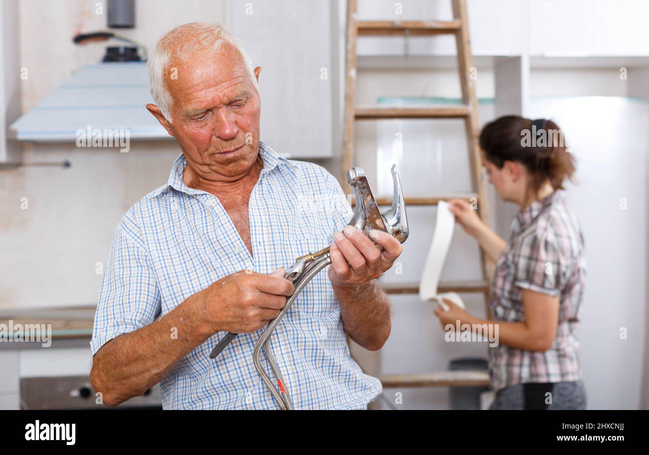Senior man with mixer tap Stock Photo - Alamy