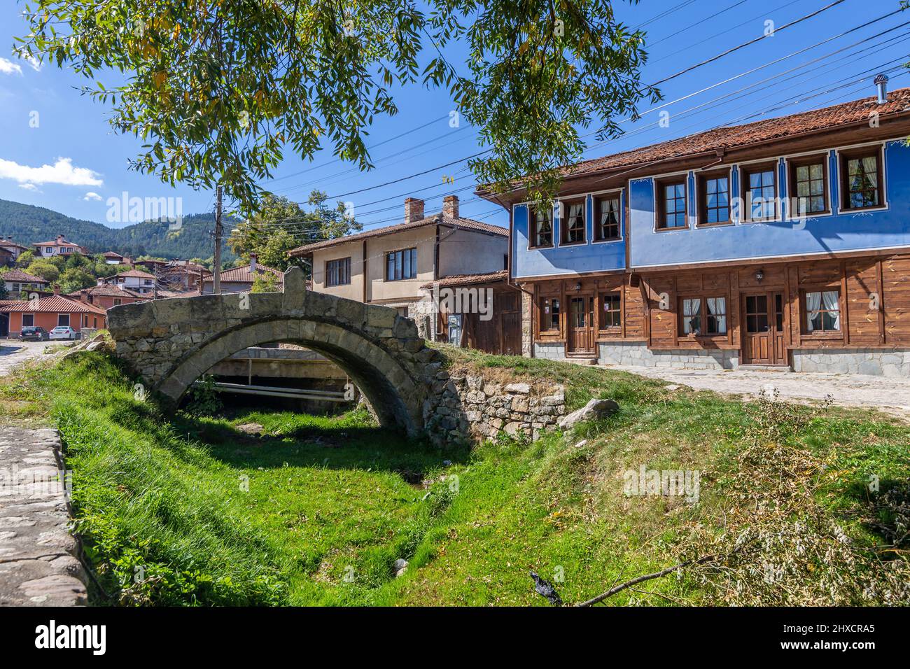 Ancient stone bridge with beautiful green grass and blue sky ...