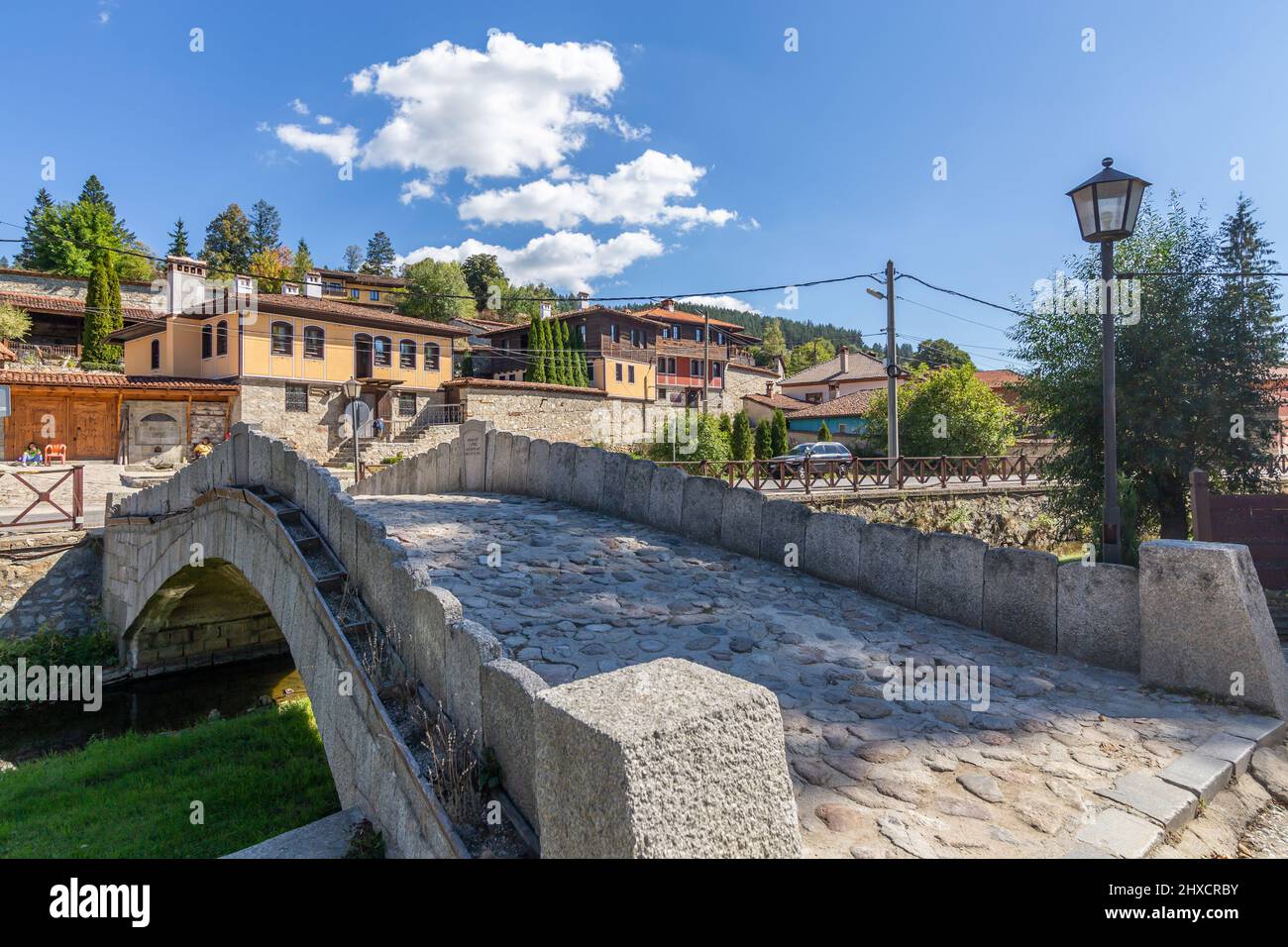 Ancient stone bridge with beautiful green grass and blue sky ...