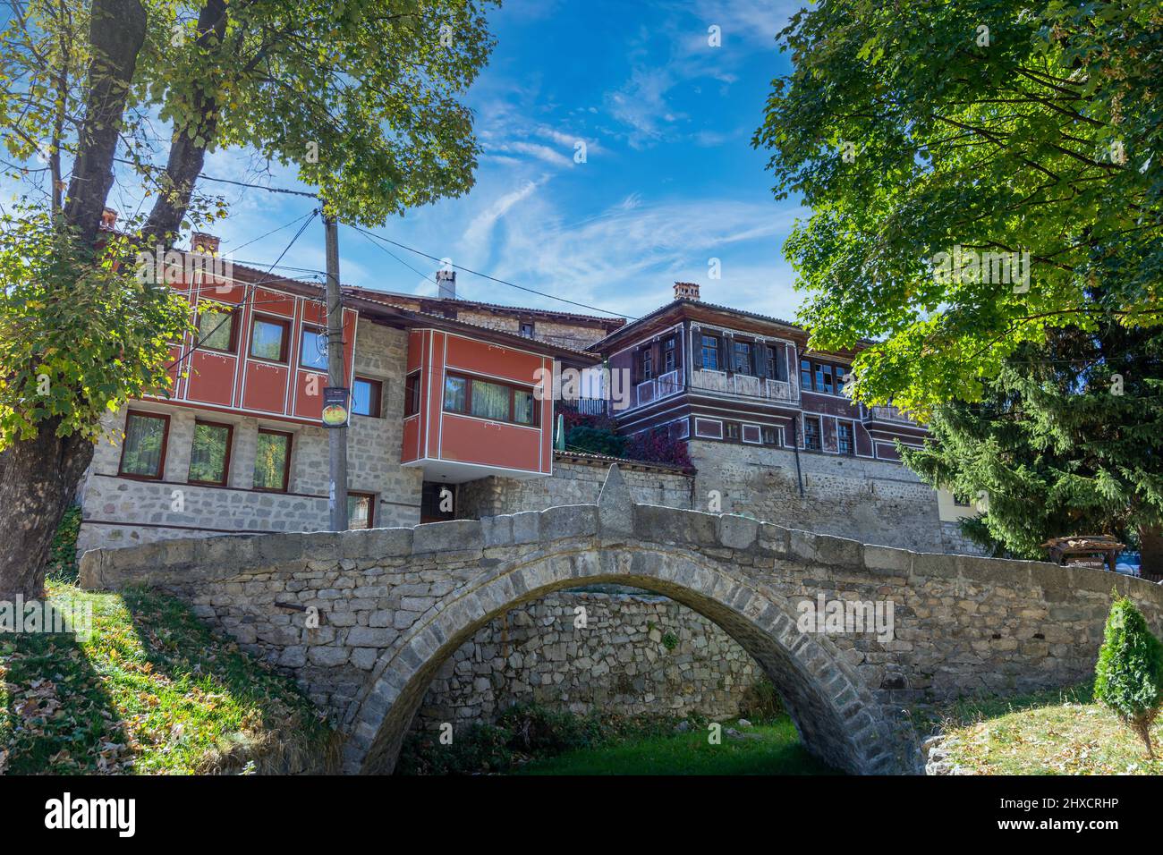 Ancient stone bridge with beautiful green grass and blue sky ...