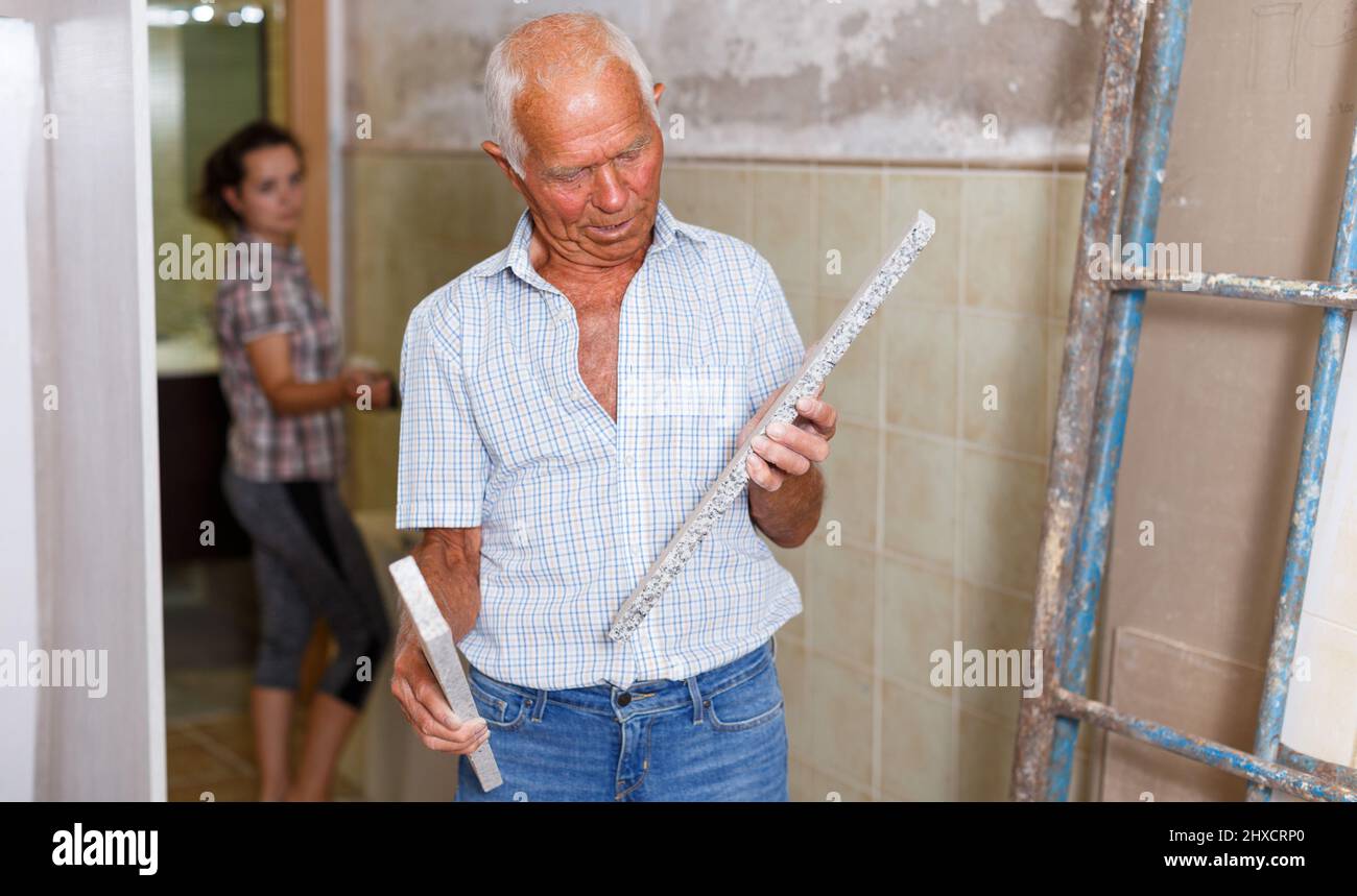 Man working on home renovations with daughter Stock Photo - Alamy