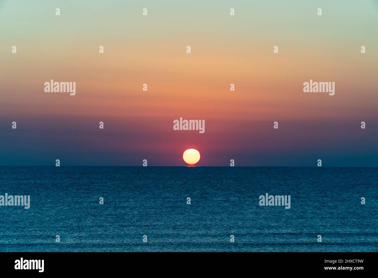 Sunrise over the sea. High angle view of the sun rising over the ...